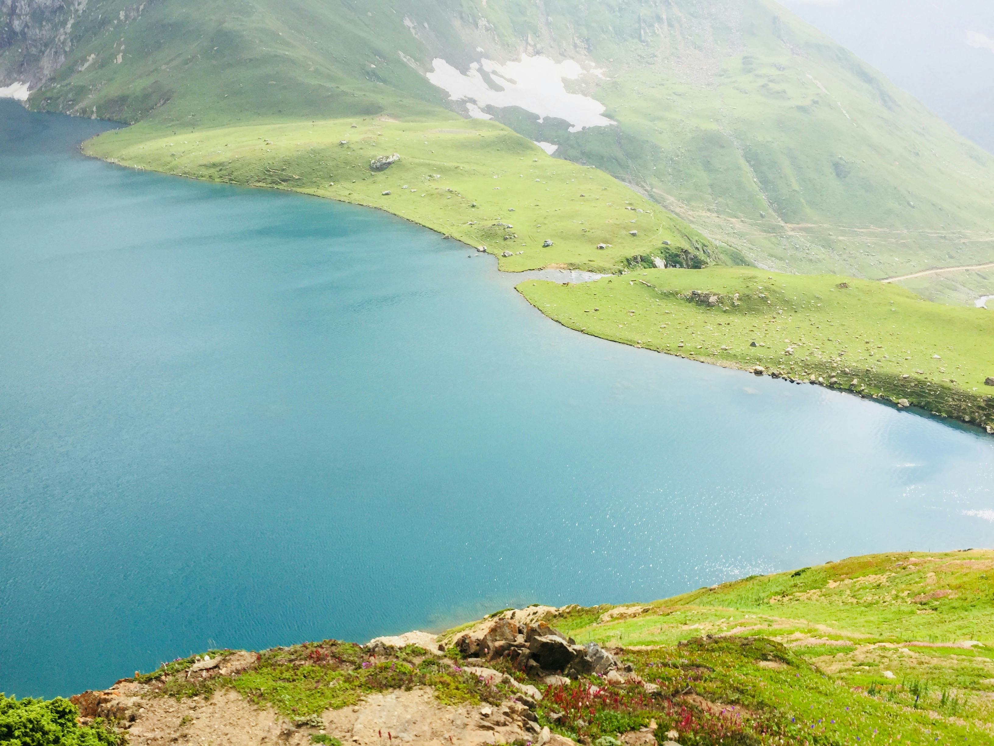Green Grass Field Near Lake · Free Stock Photo