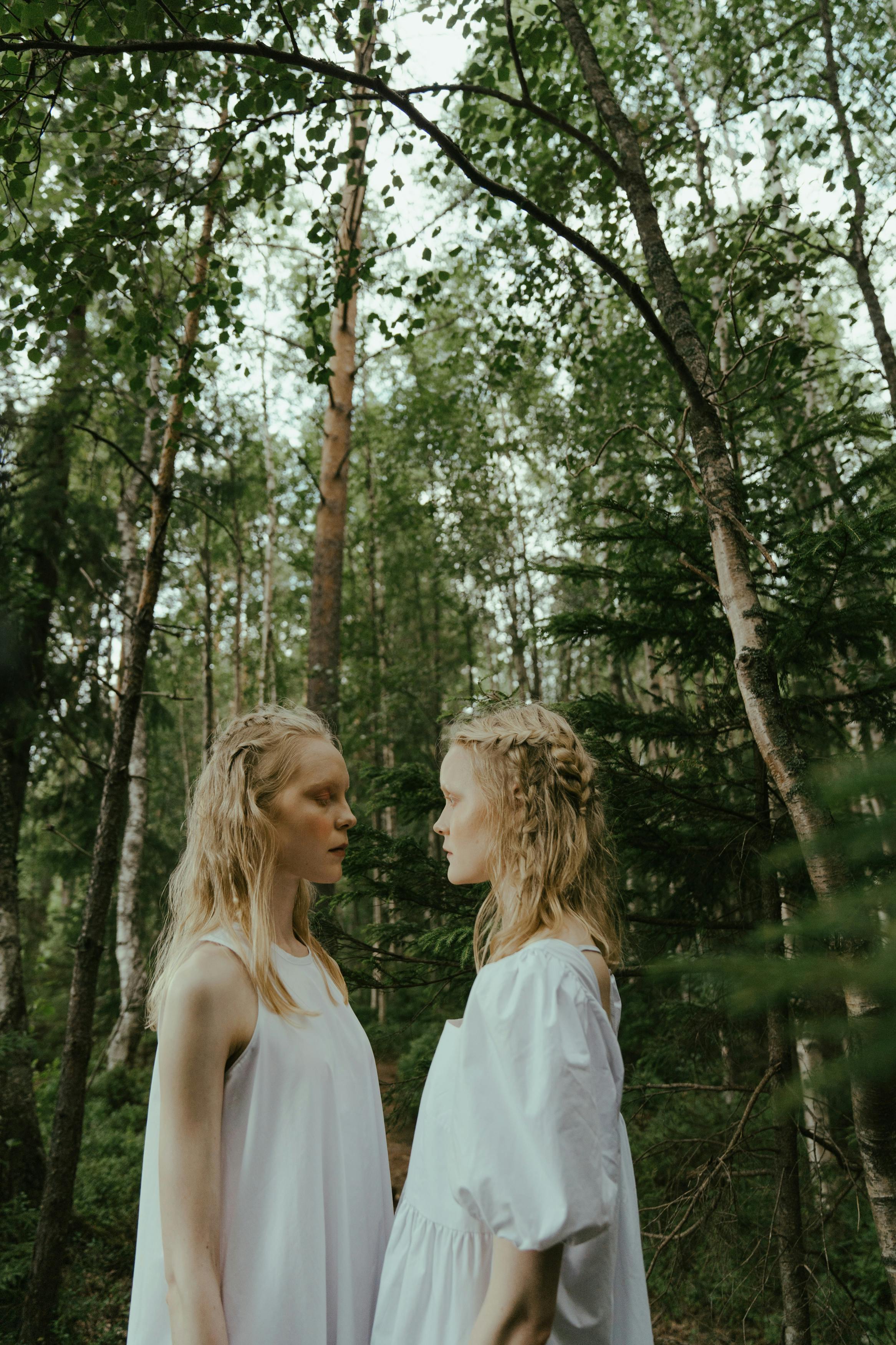 Twin Sisters Standing in a Forest · Free Stock Photo