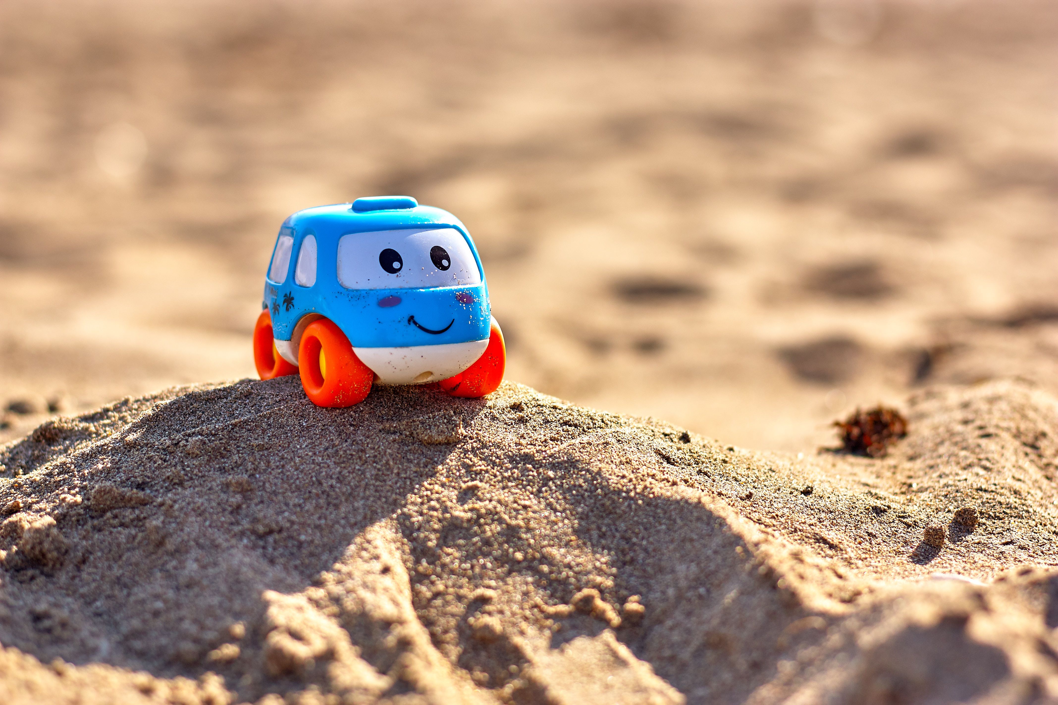 Blue and White Toy Car on Beach Sand · Free Stock Photo