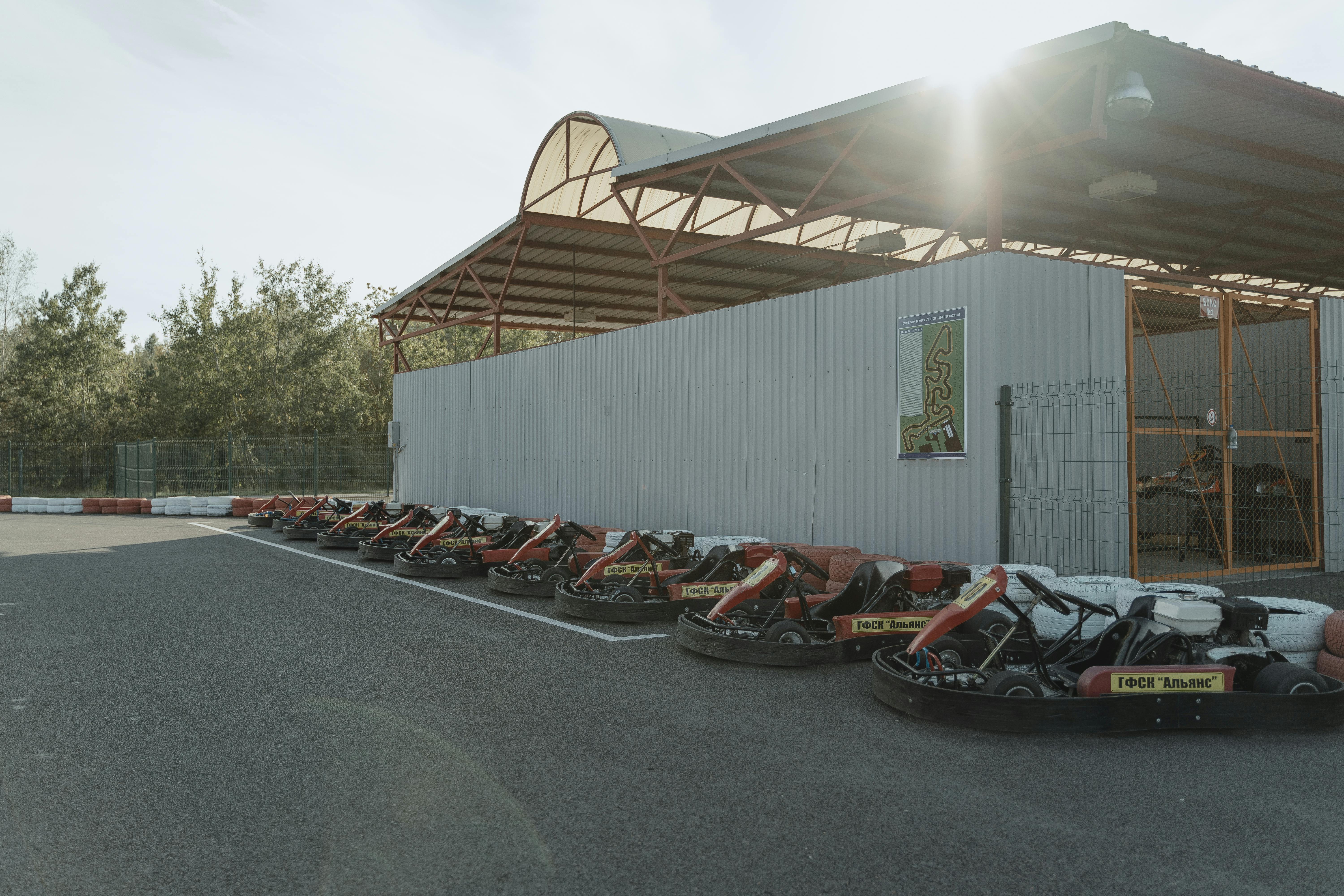 Row of Go-Karts Parked near the Garage · Free Stock Photo