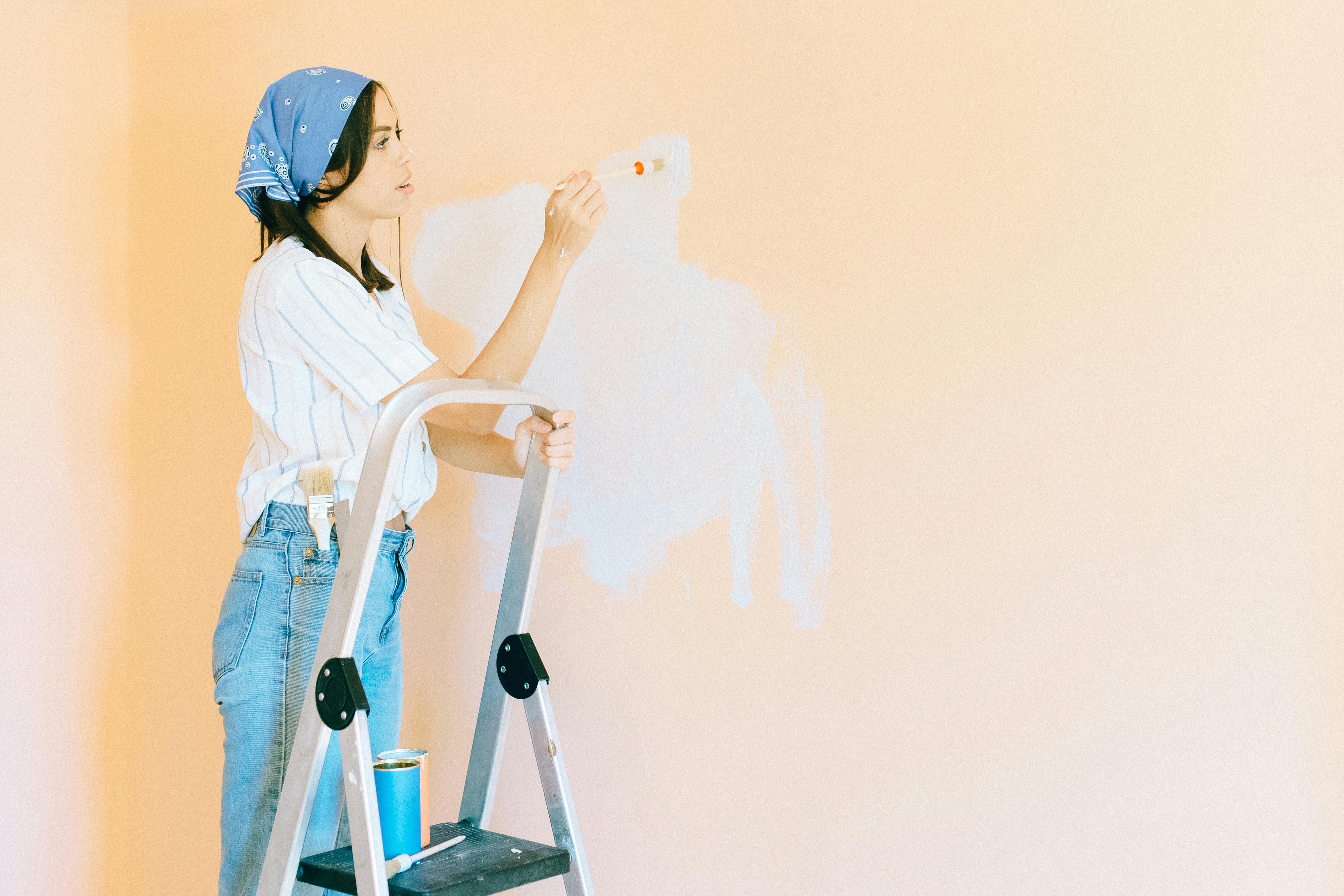 A Person Painting the Wall White · Free Stock Photo