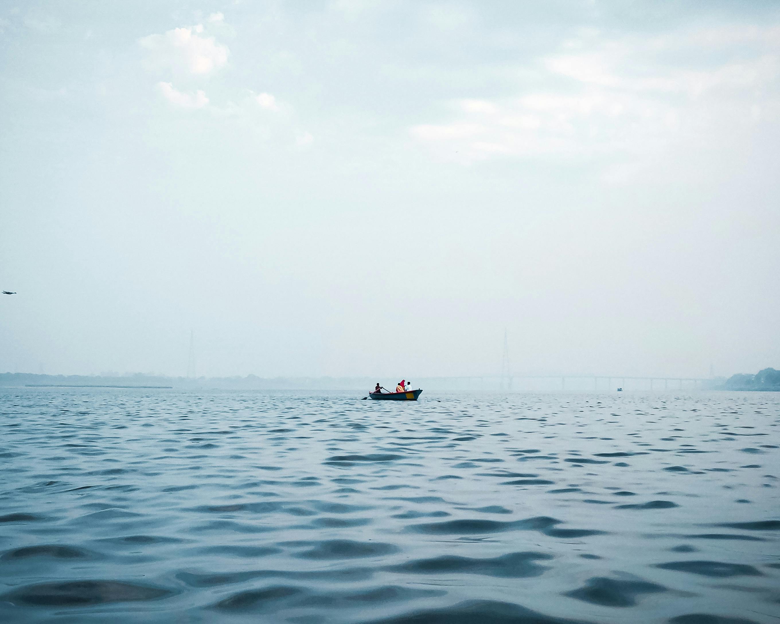Rowboat in Sea at Dawn · Free Stock Photo