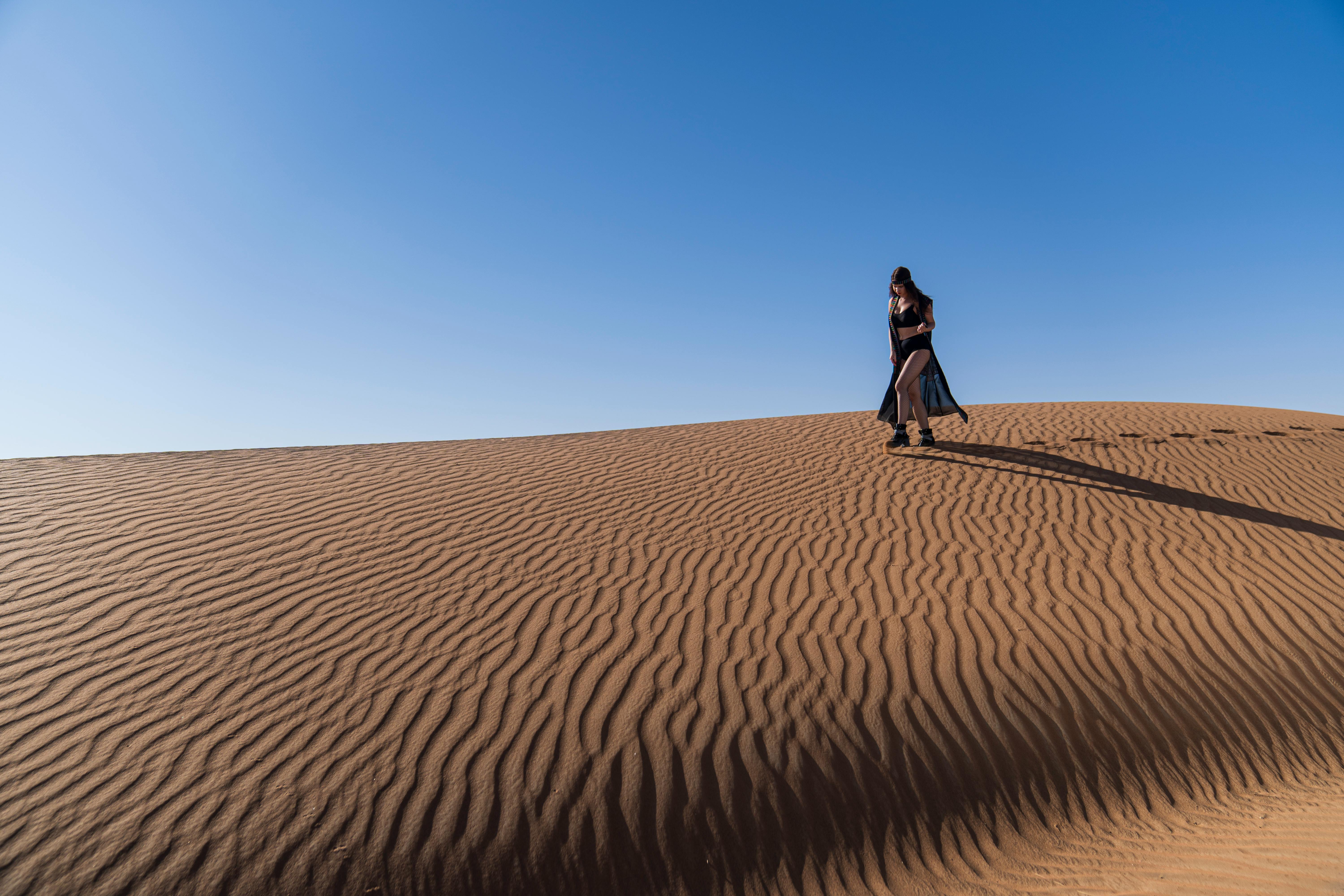 Woman Walking in Desert · Free Stock Photo