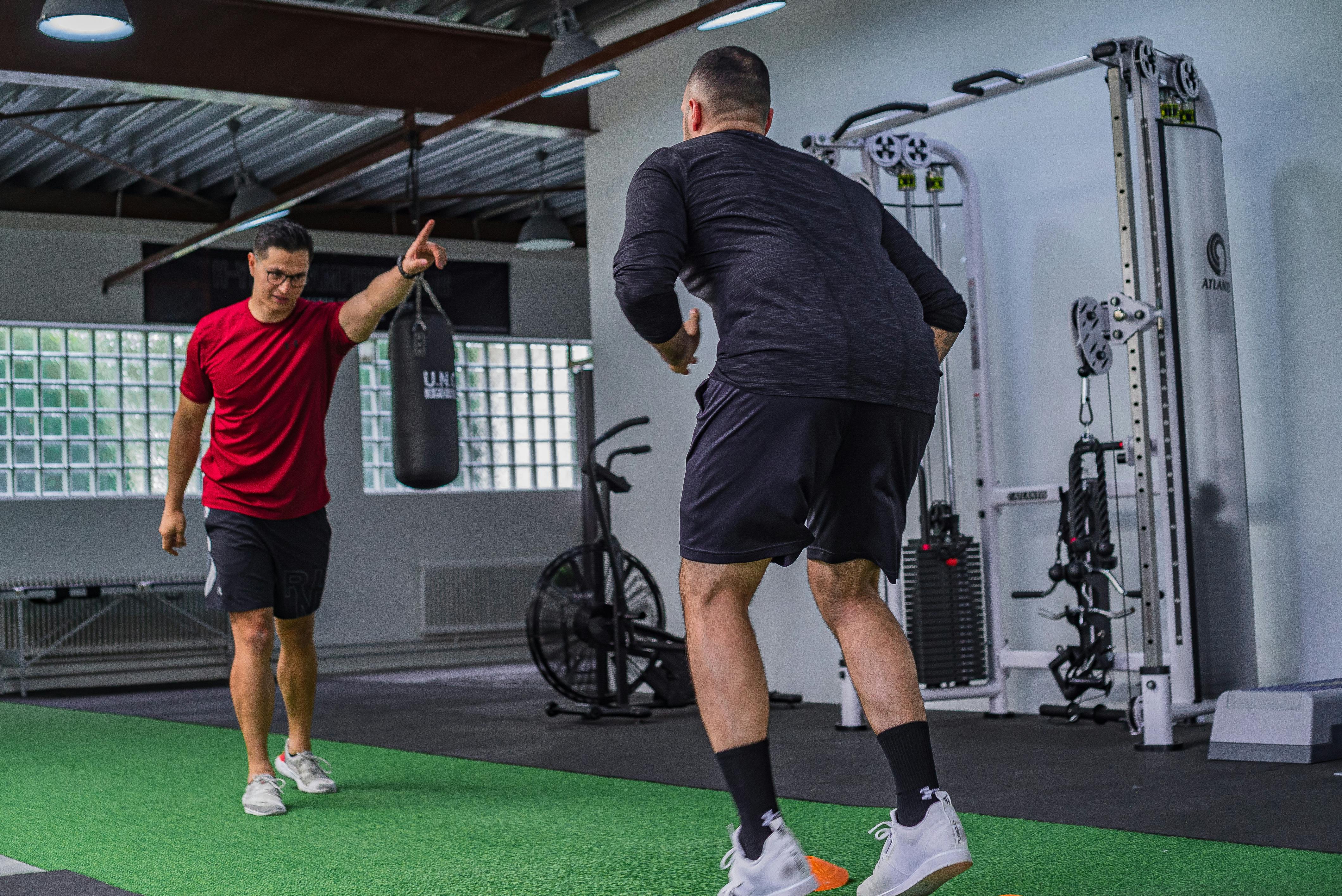 Content diverse sportspeople clapping hands in gym · Free Stock Photo