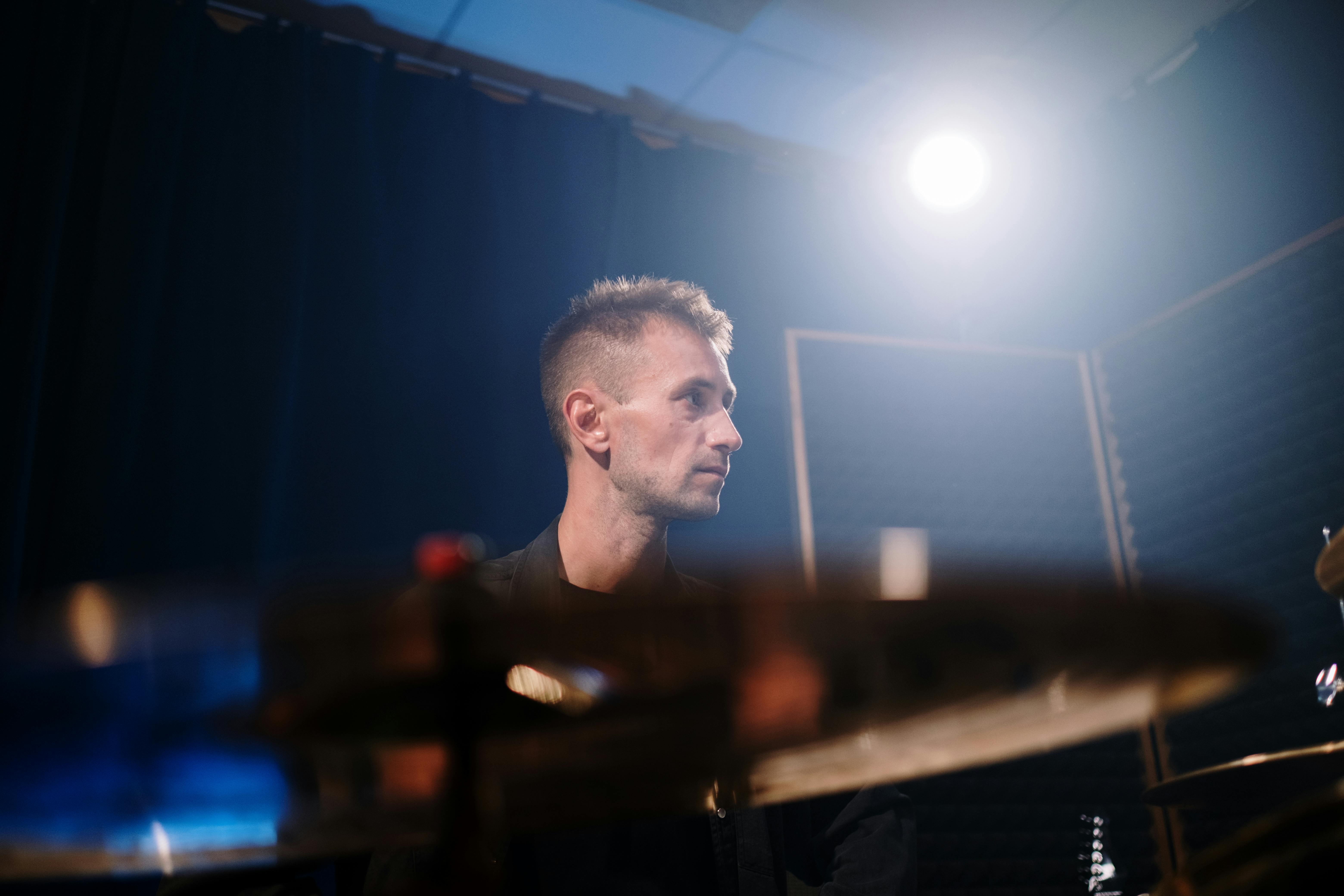 A Man in the Studio with Spotlight · Free Stock Photo
