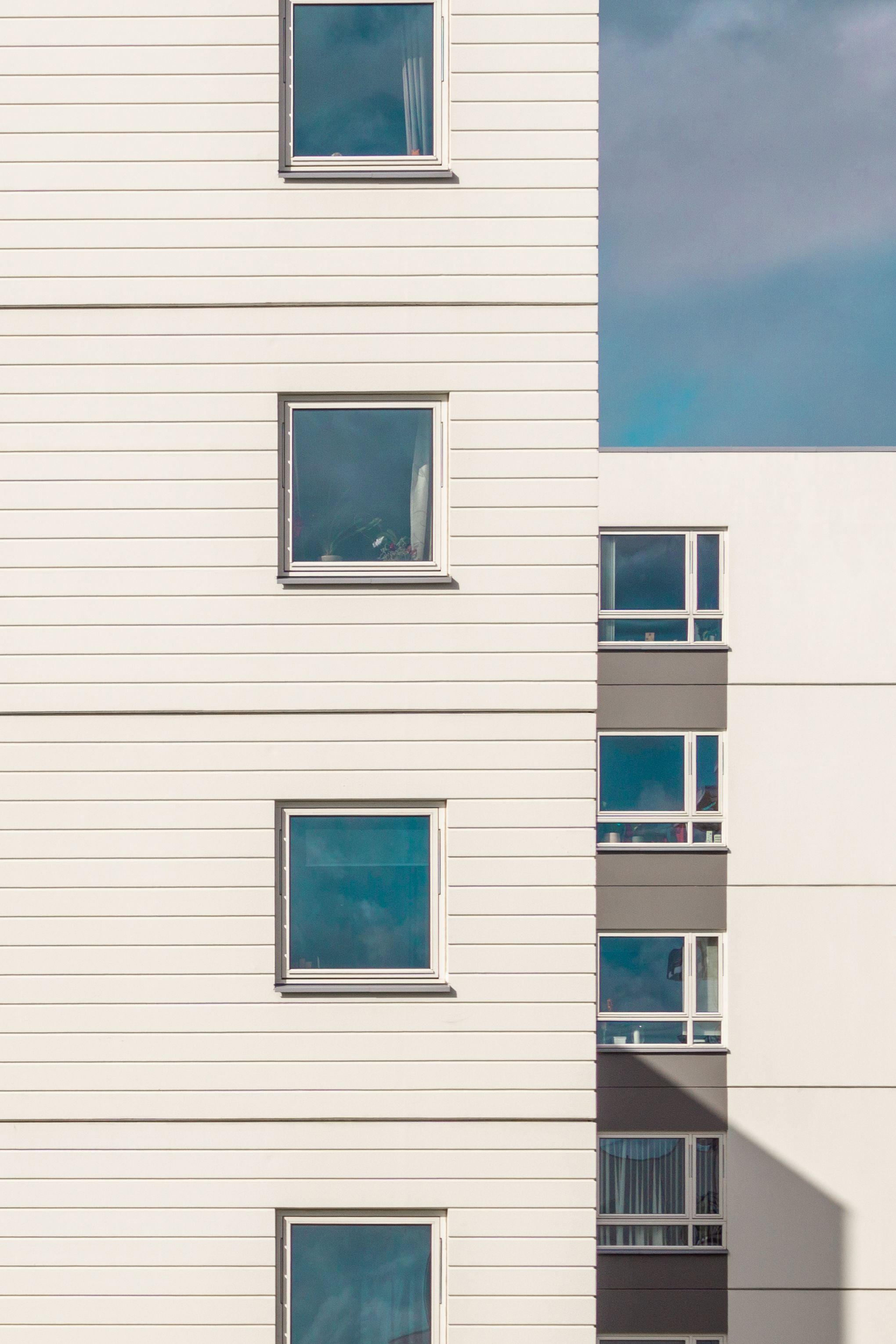 White Building With Blue Glass Windows · Free Stock Photo