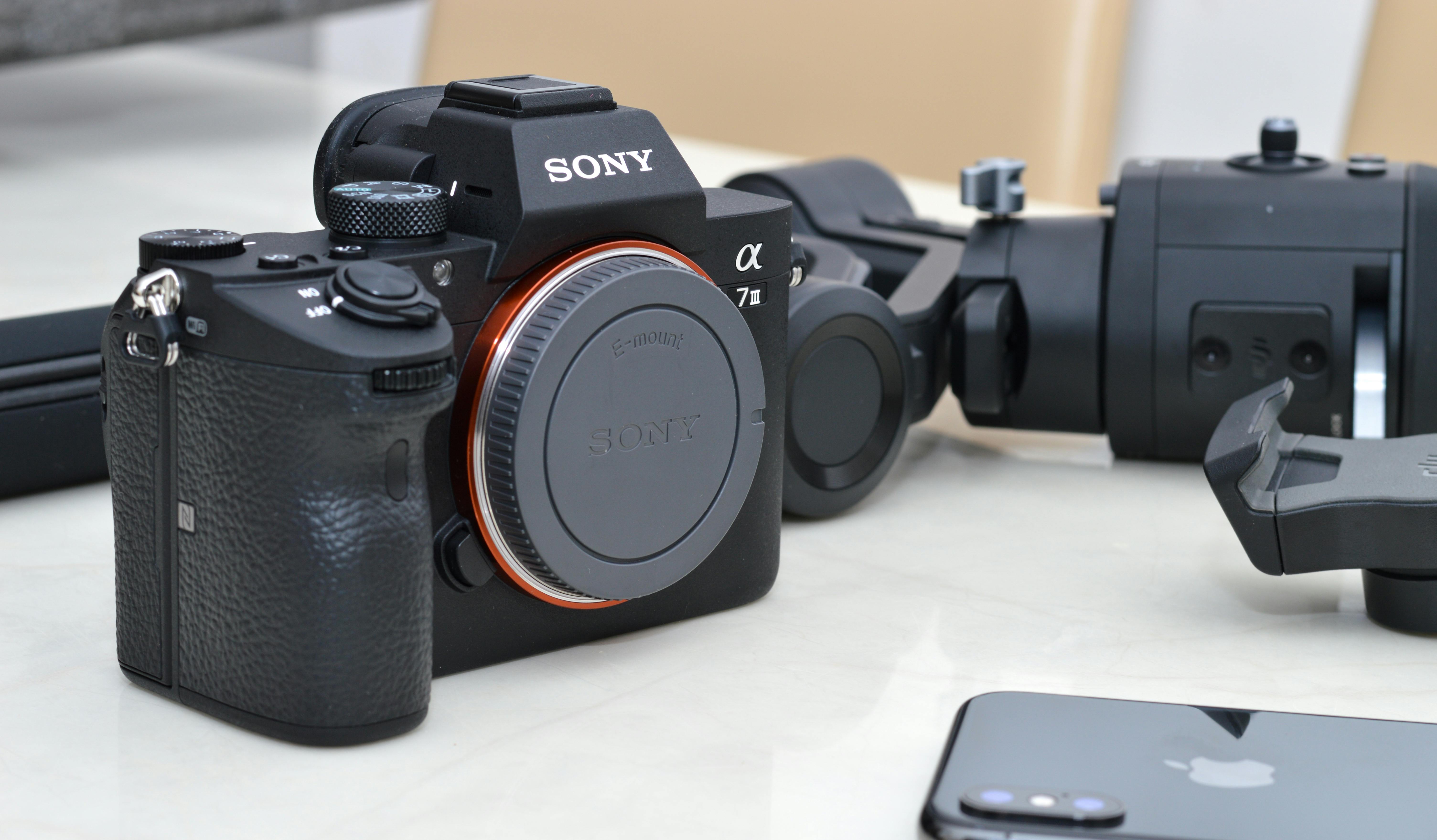 Black Sony DSLR Camera on White Table · Free Stock Photo