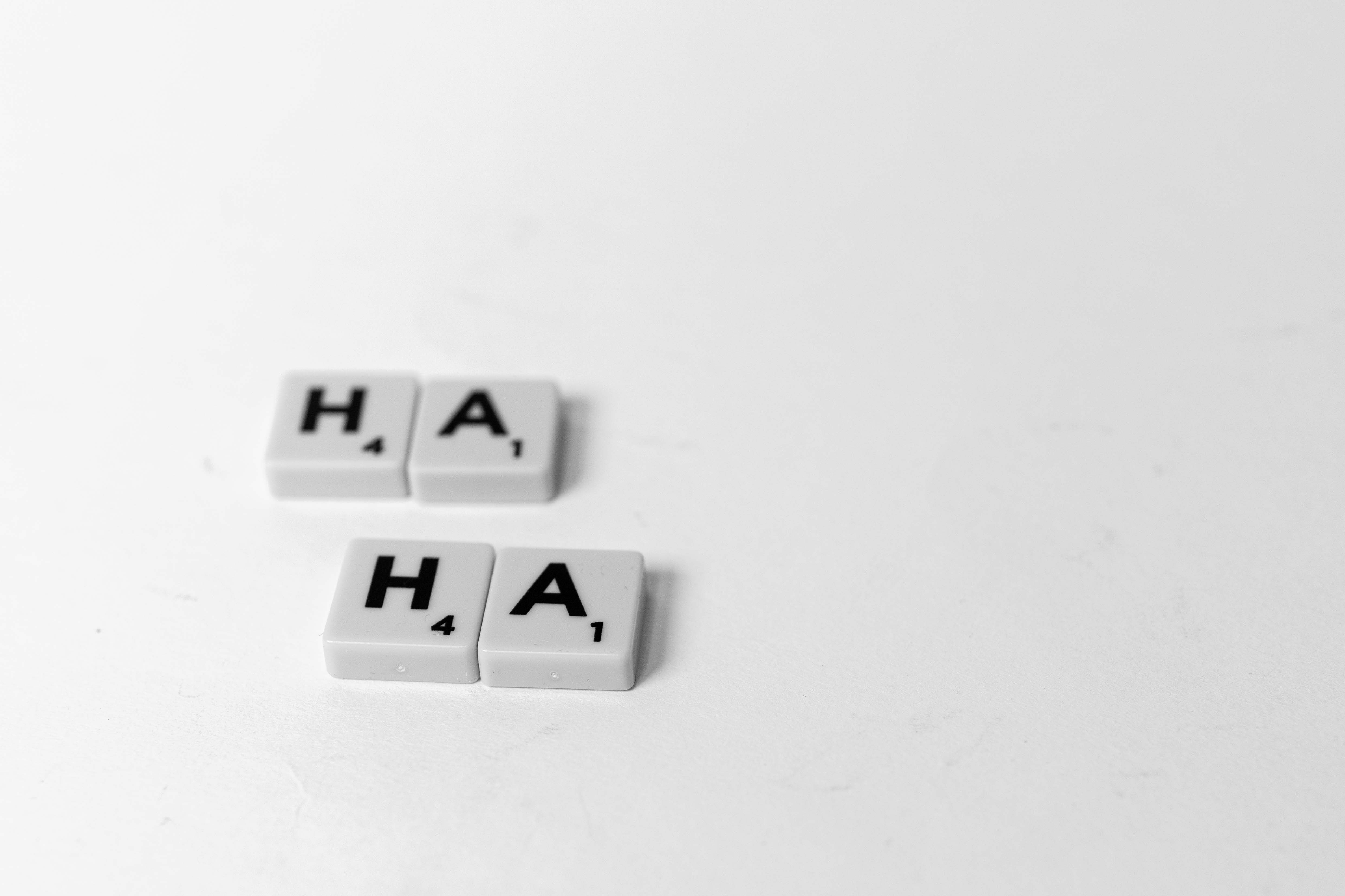Scrabble Tiles Beside Flowers on White Background · Free Stock Photo