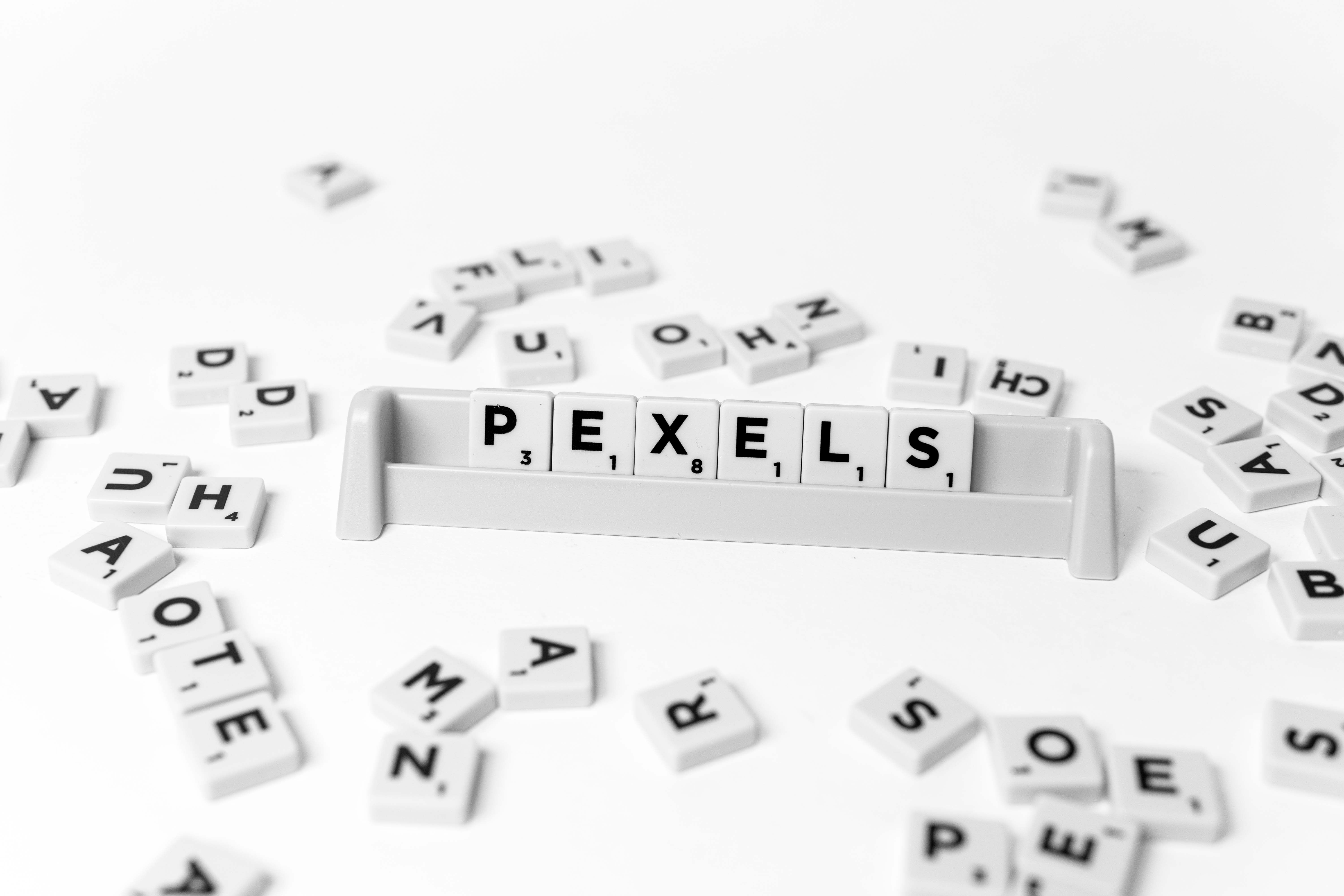 Close-up of a Word and Scattered Tiles with Letters from a Word Game ...