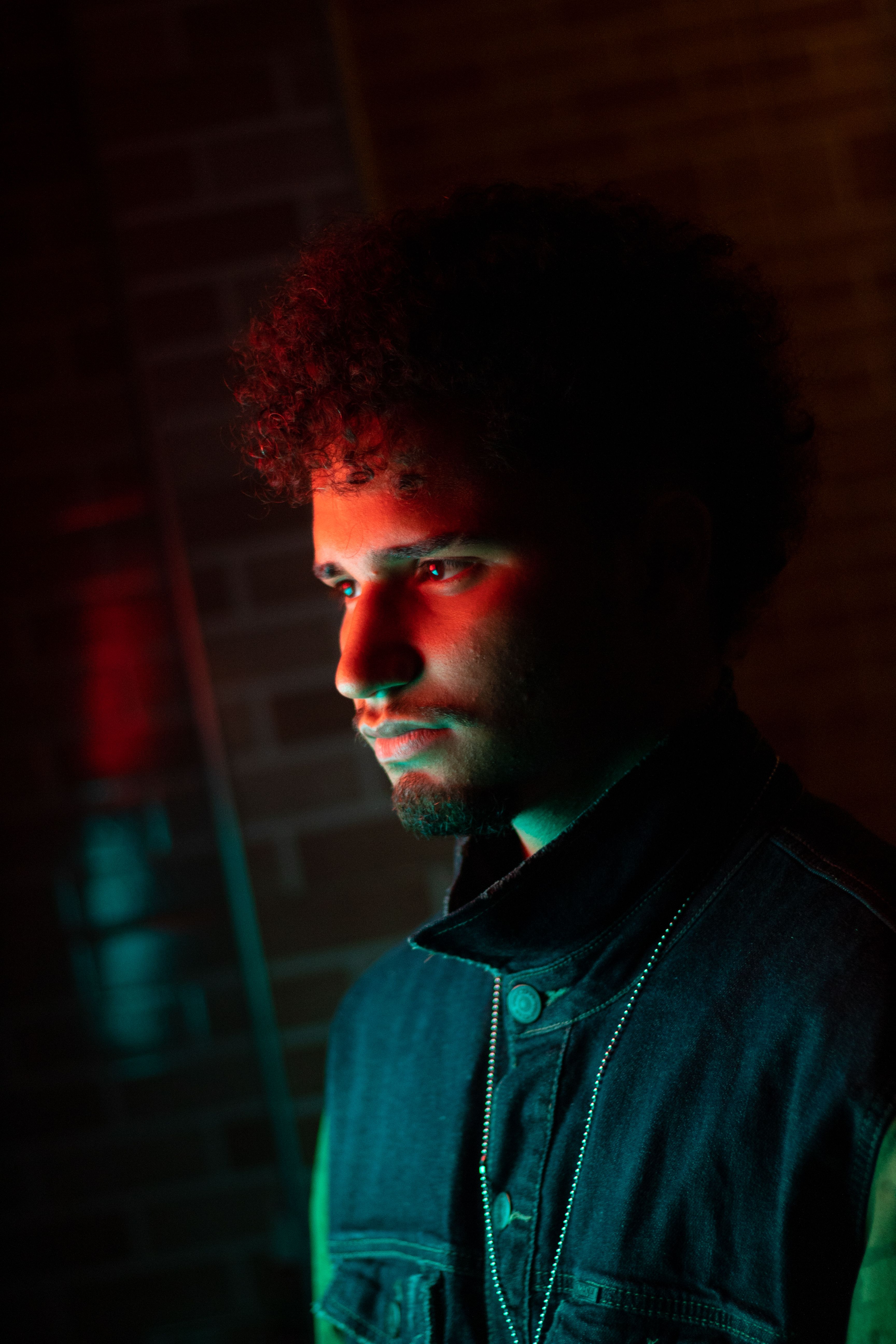 Side View of a Man wearing Green Jacket · Free Stock Photo