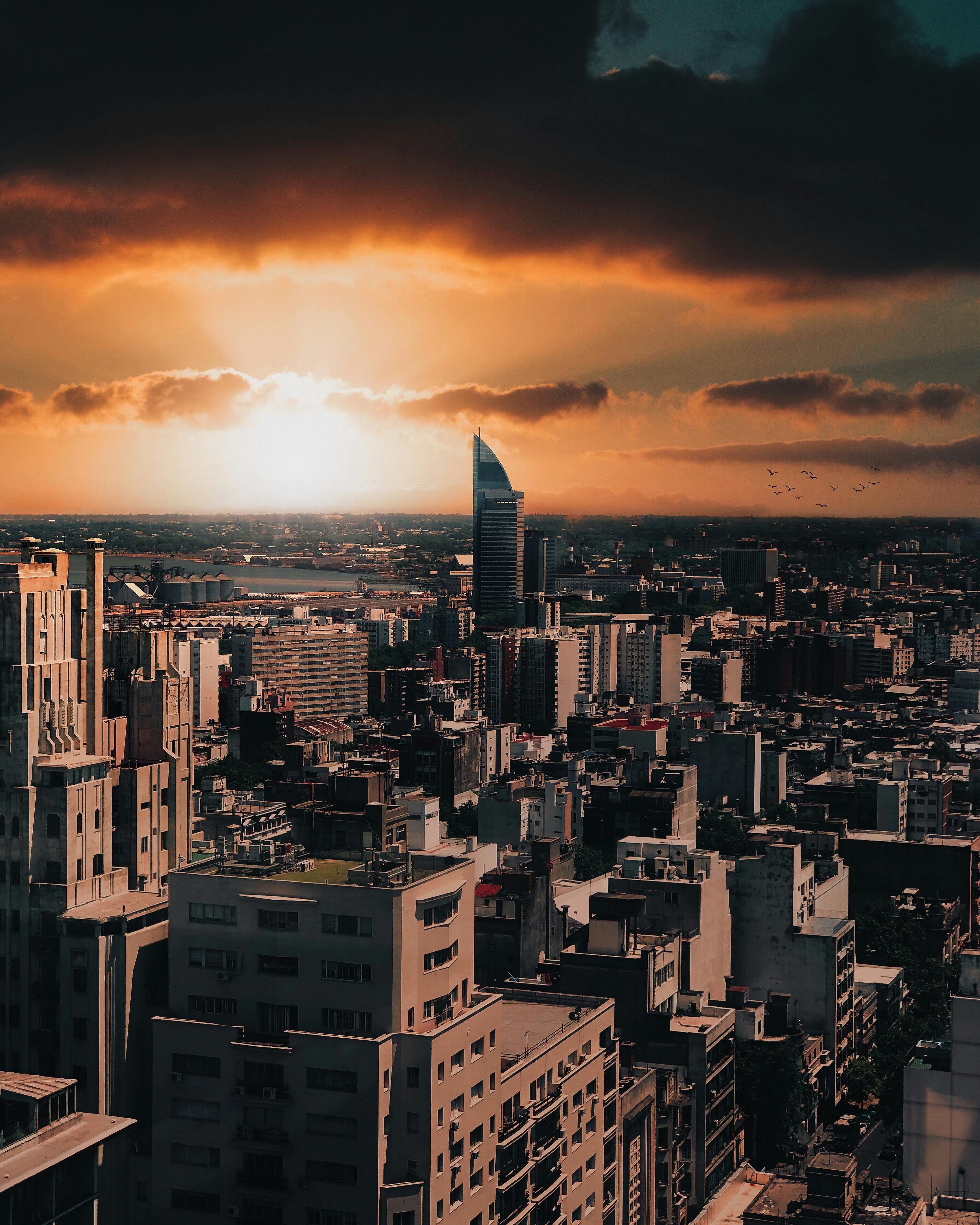 The Sun Setting Over City Buildings · Free Stock Photo