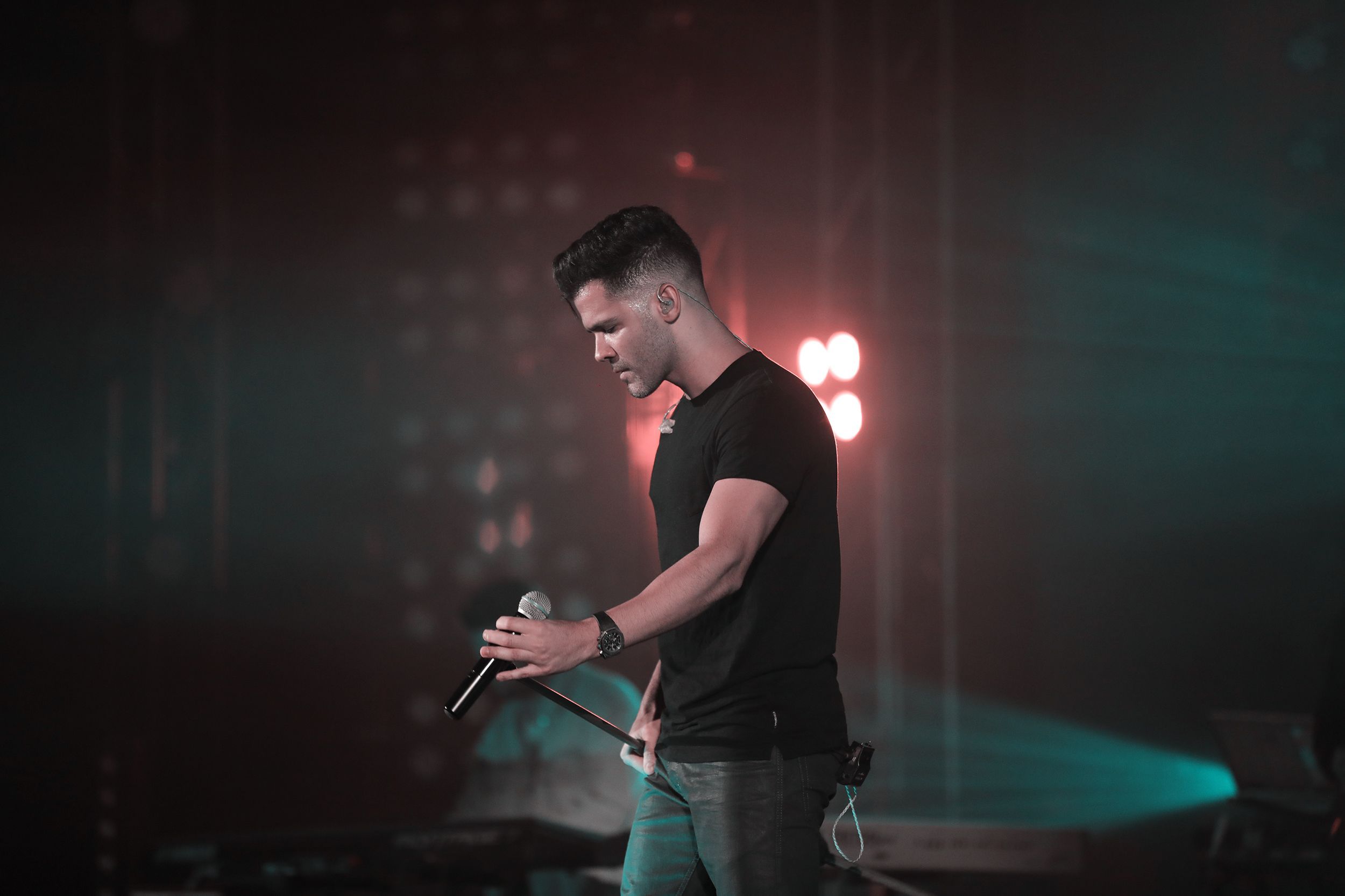 Singer Wearing Brown Hat Singing on Stage · Free Stock Photo