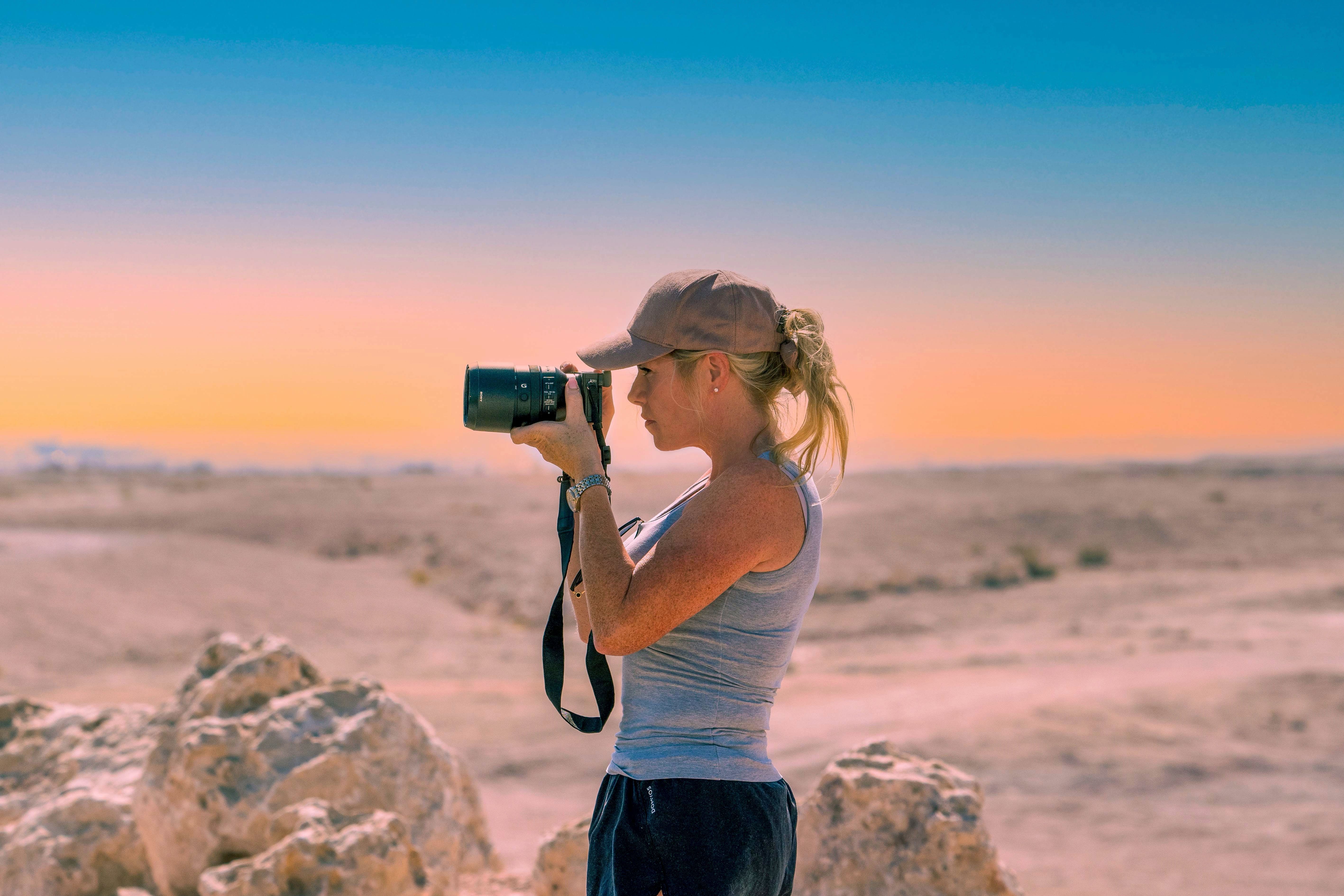 Anonymous photographer enjoying sunset time in nature · Free Stock Photo