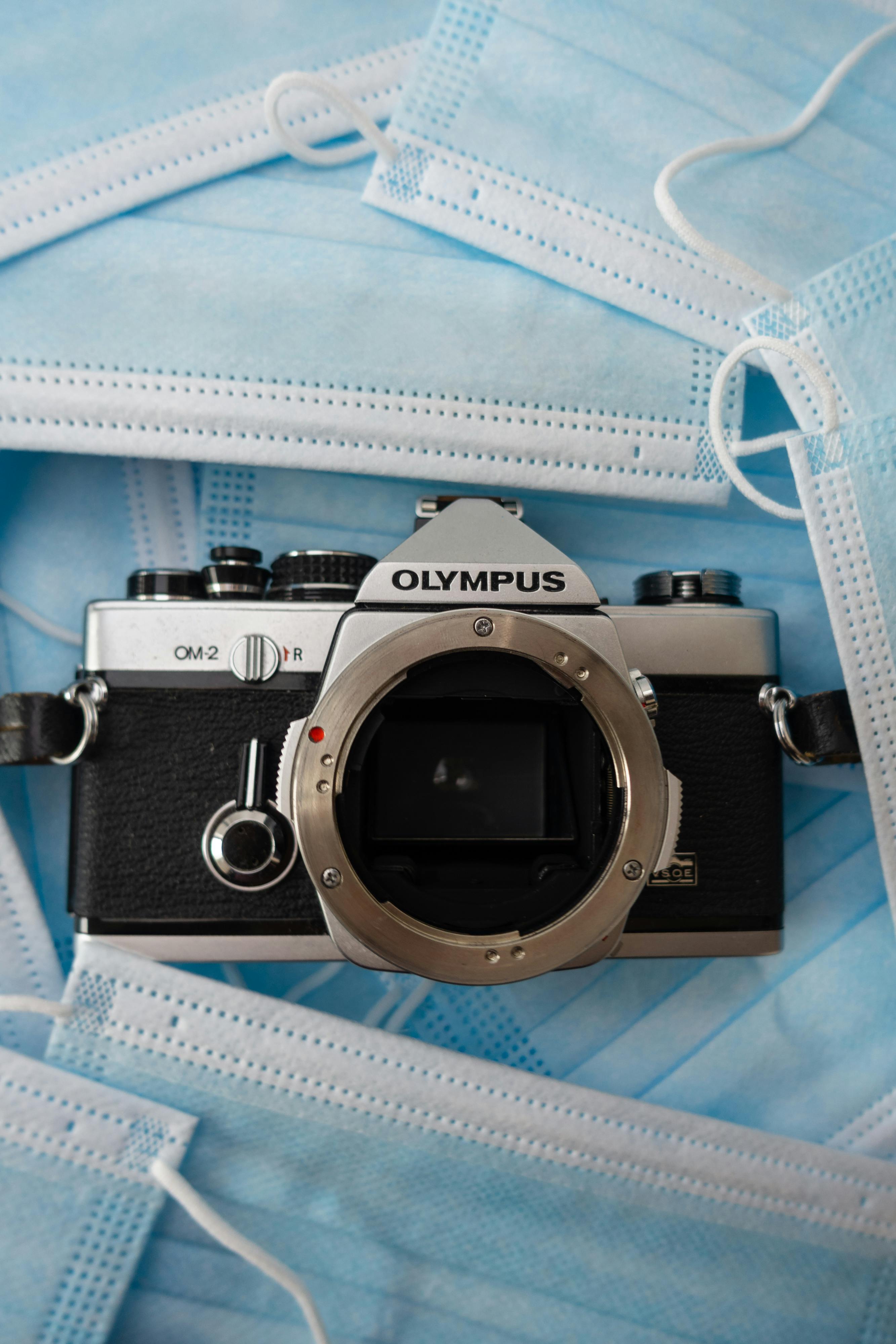 Olympus Camera on Top of Surgical Face Masks · Free Stock Photo