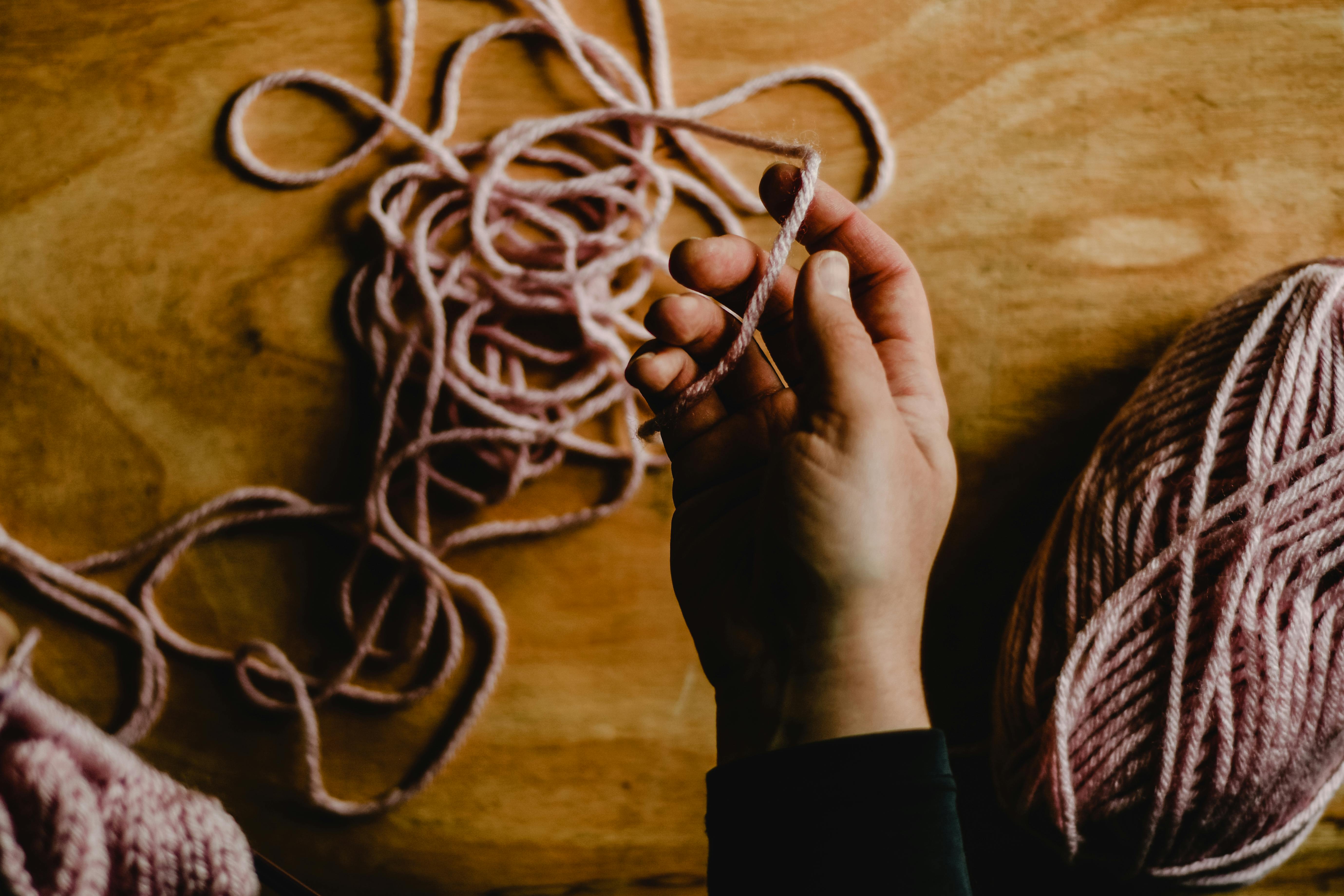 Close up of Hand Holding Thread · Free Stock Photo
