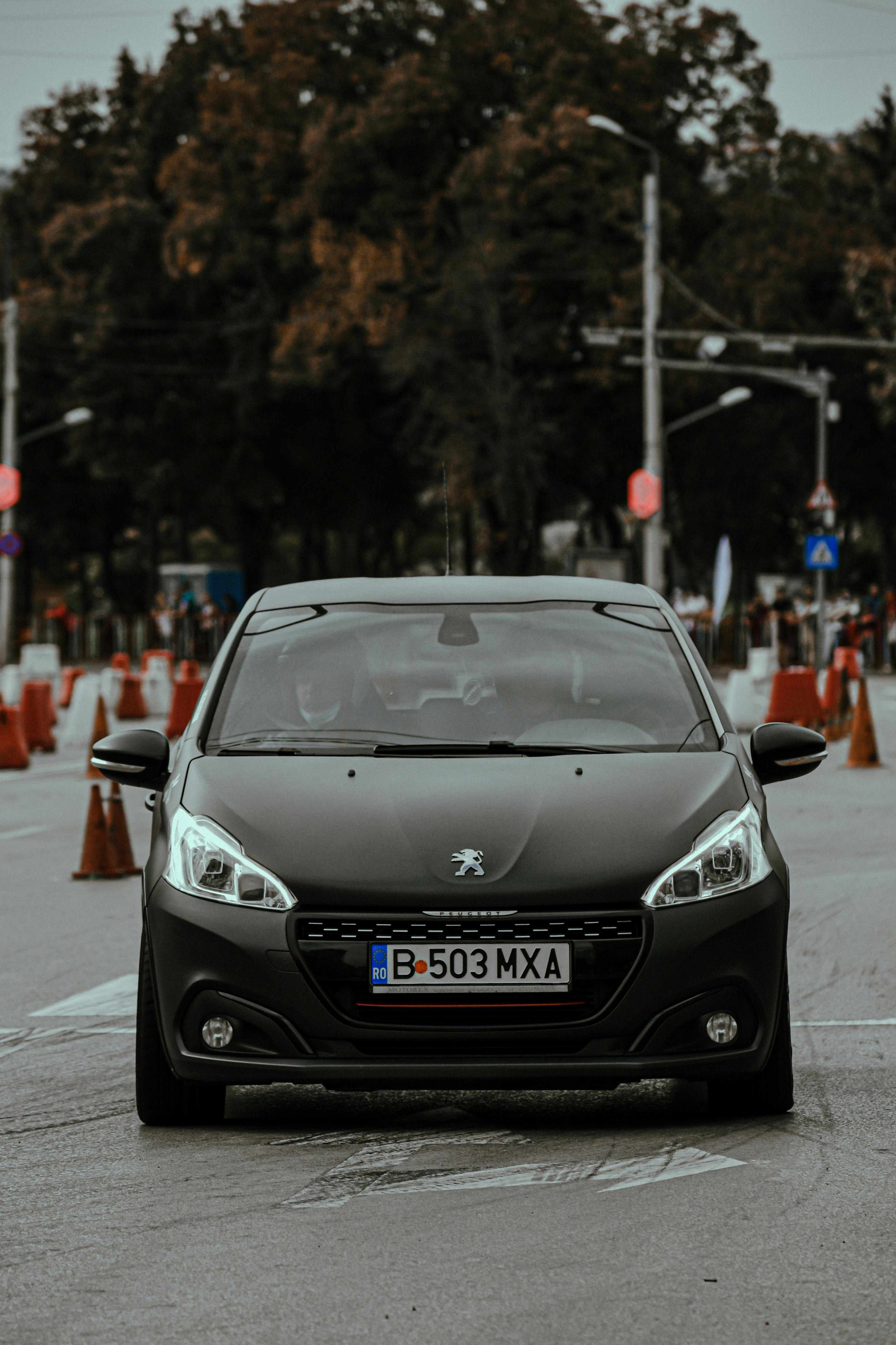 Black car racing down street · Free Stock Photo