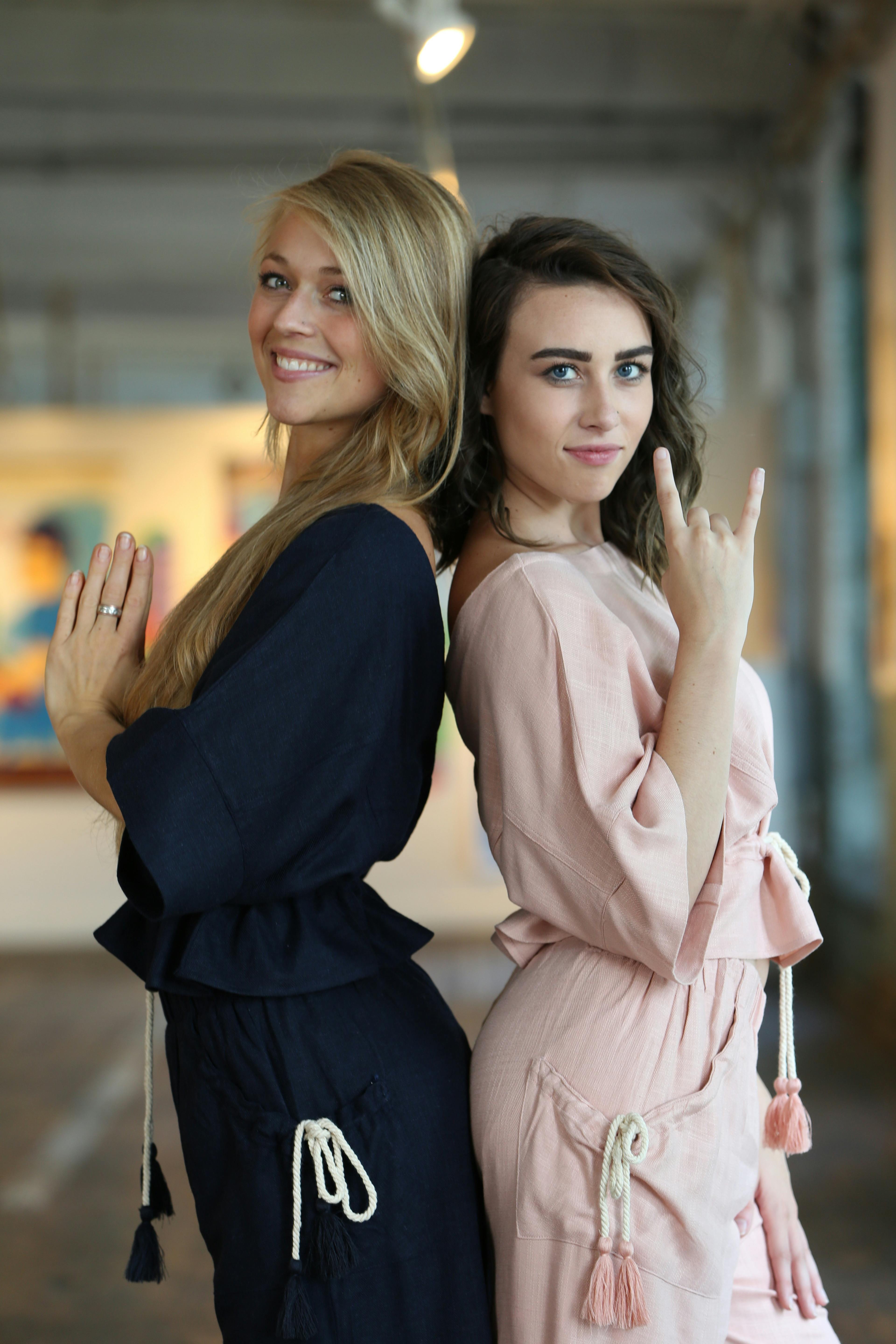 Women Standing Back to Back · Free Stock Photo