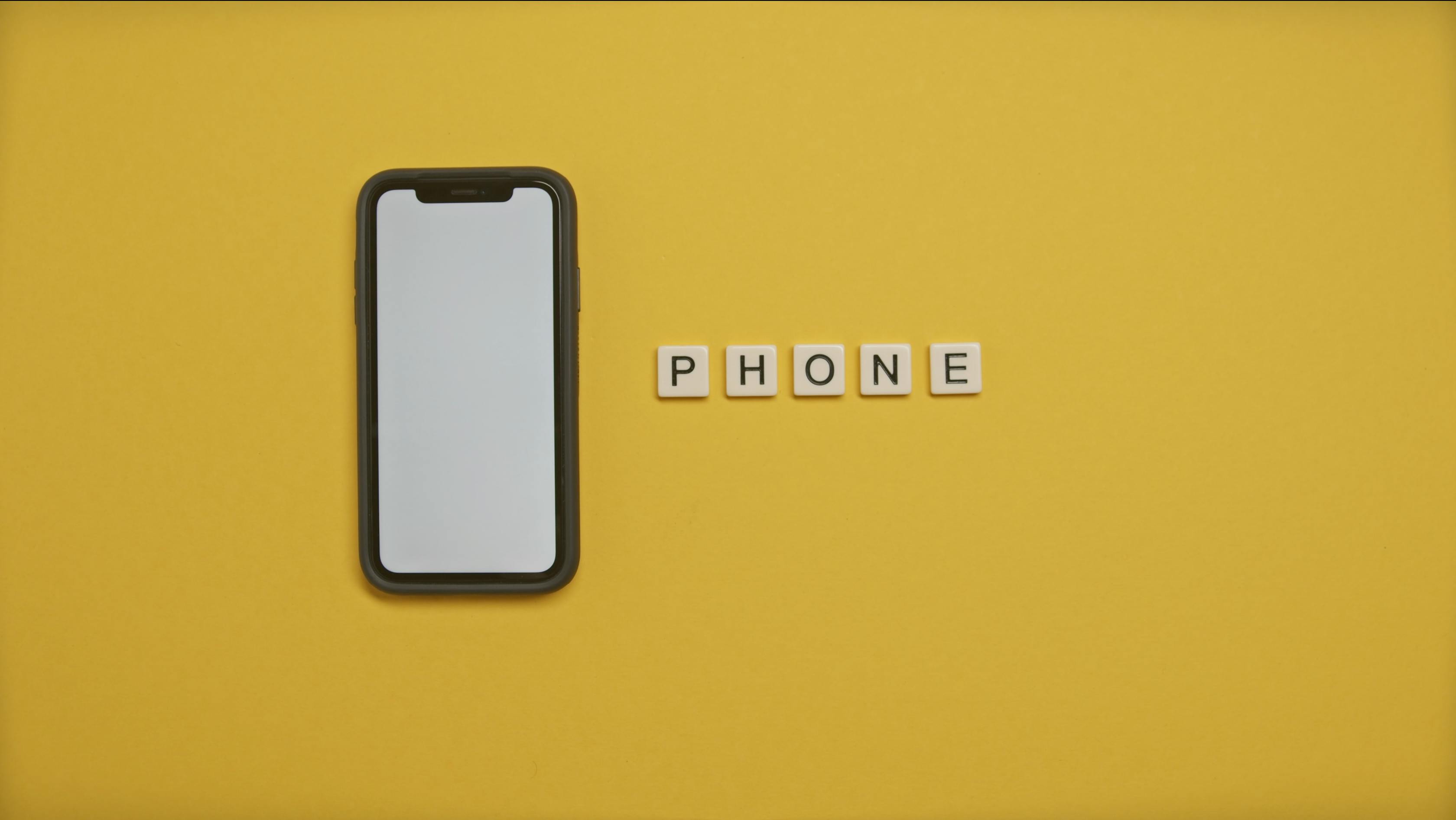 Black Smartphone on Yellow Background · Free Stock Photo