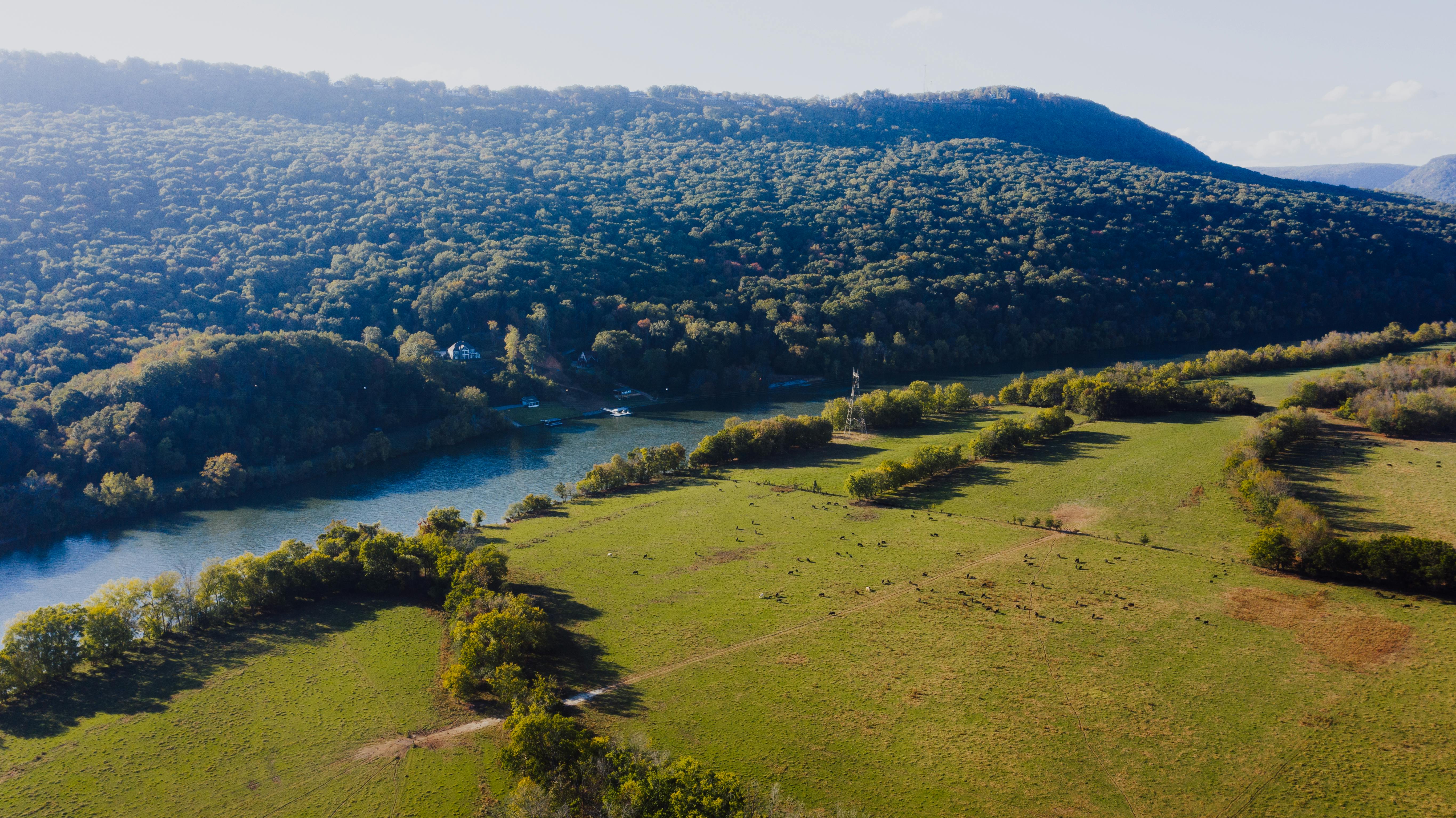 Boat floating on blue tranquil lake in verdant highlands · Free Stock Photo