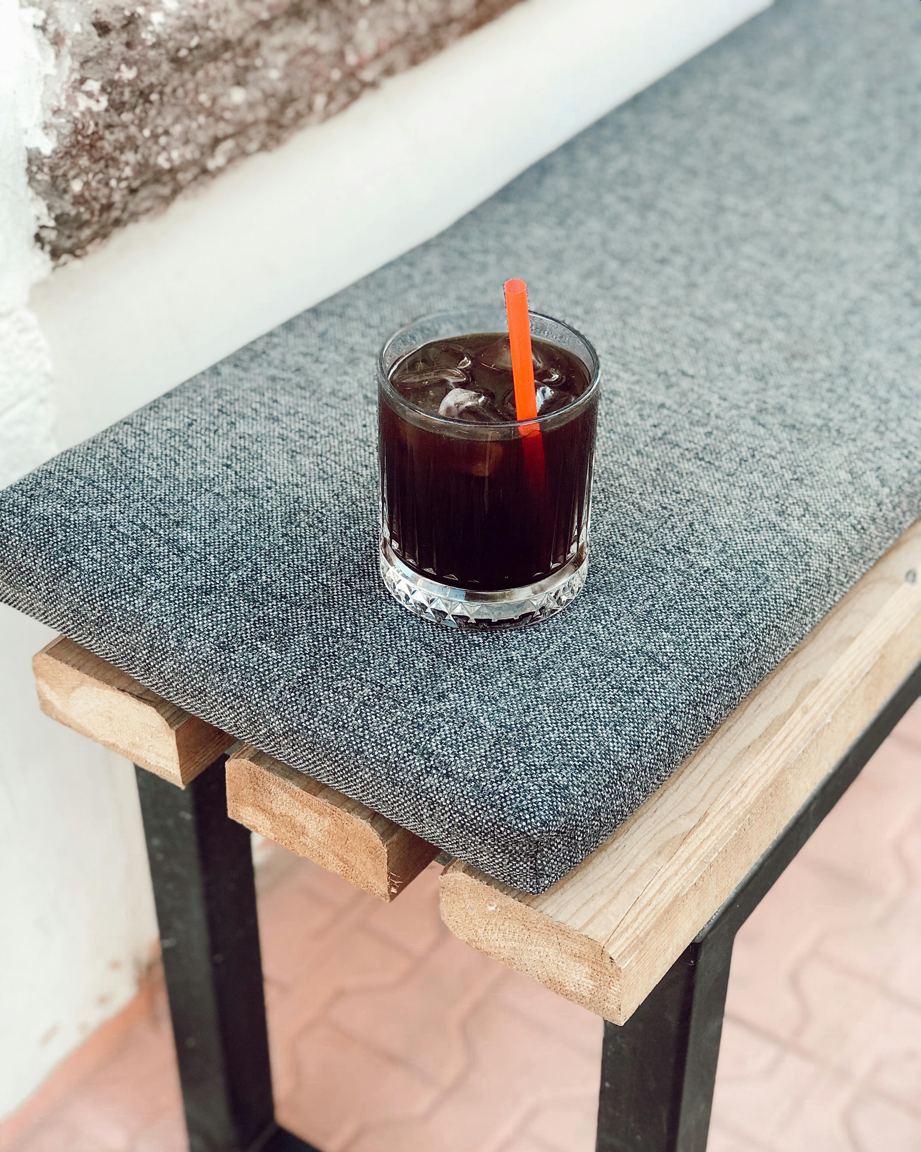 Summer Drink on a Patterned Bench · Free Stock Photo