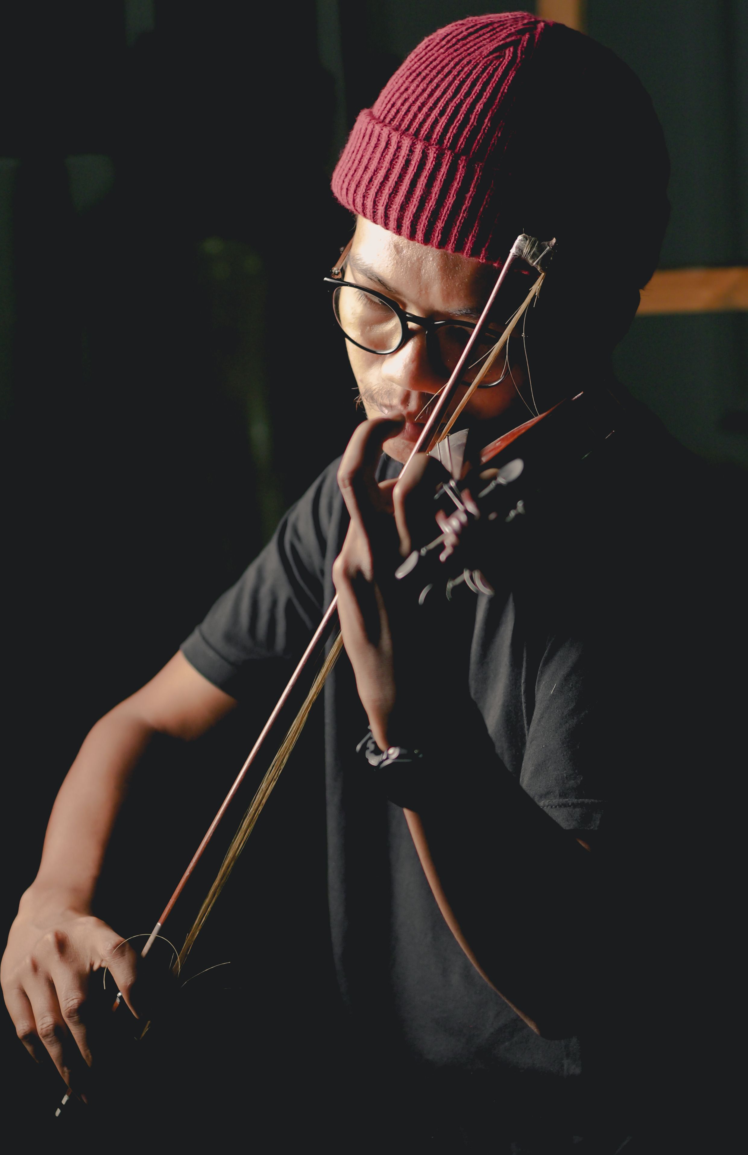 A Person Playing Violin while Holding a Violin Bow · Free Stock Photo