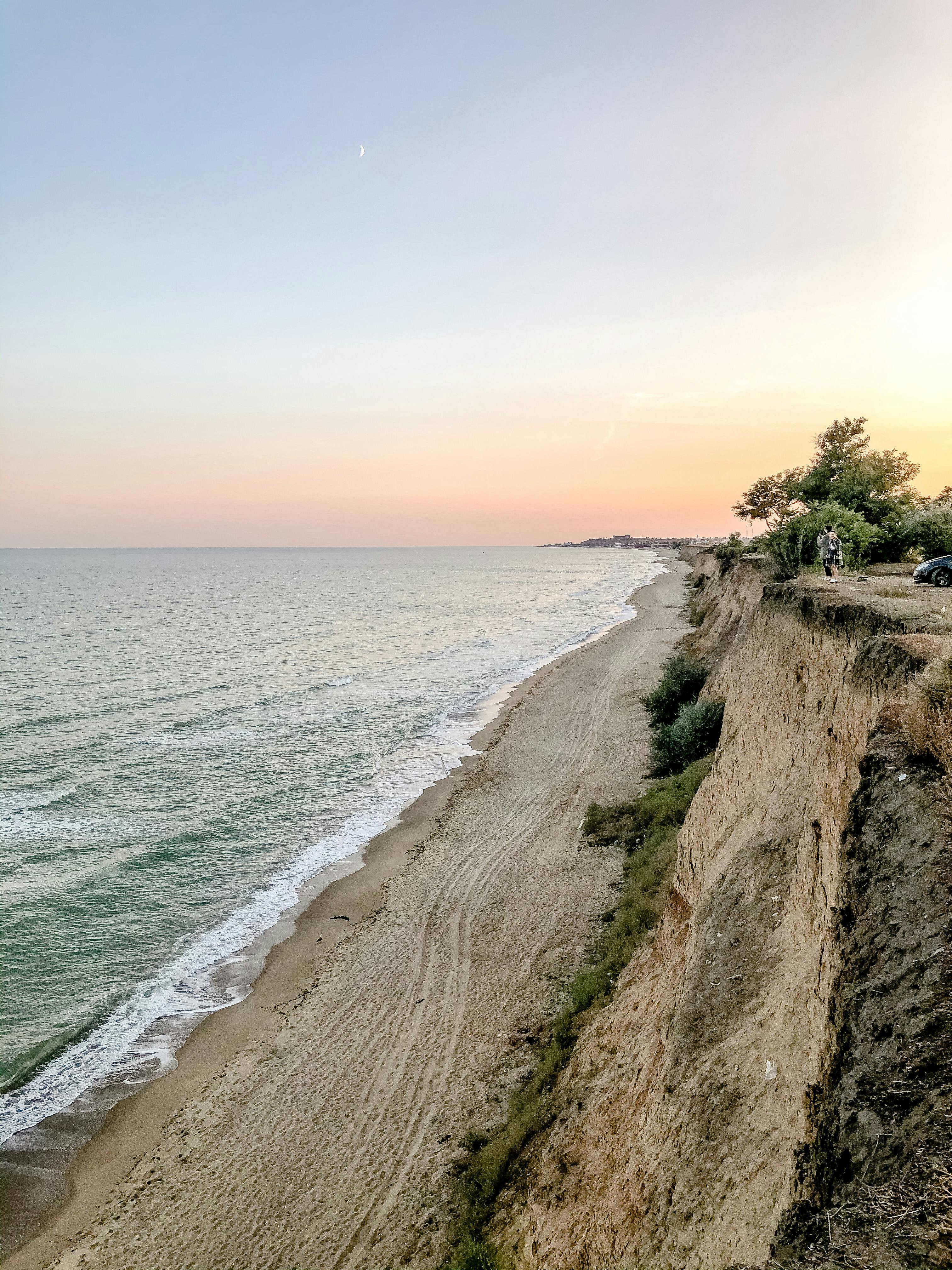 Cliff on a Seashore at Sunset · Free Stock Photo