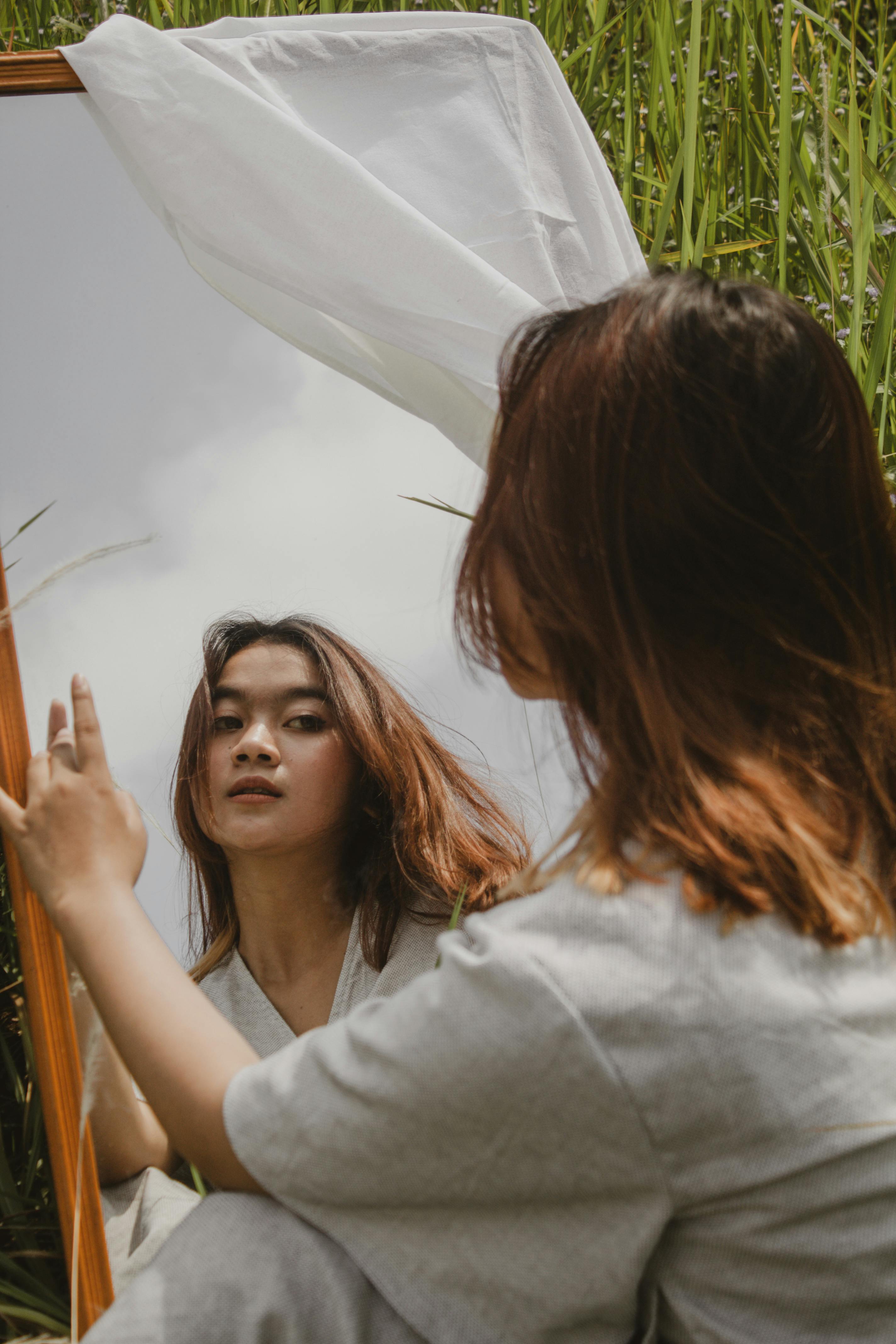 A Woman with Scars on Her Body Looking at a Mirror · Free Stock Photo