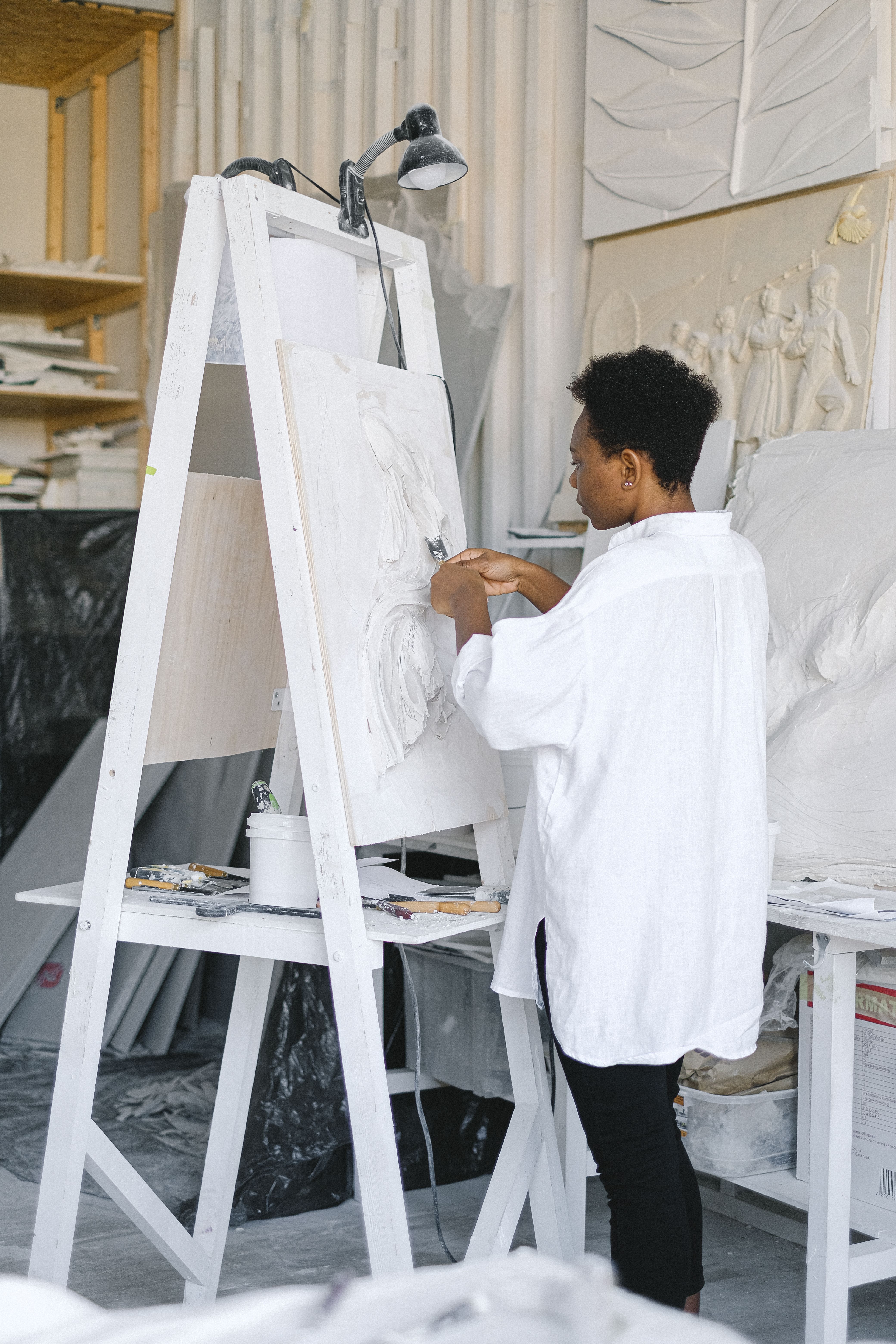 Artist Standing Beside an Easel Stand · Free Stock Photo