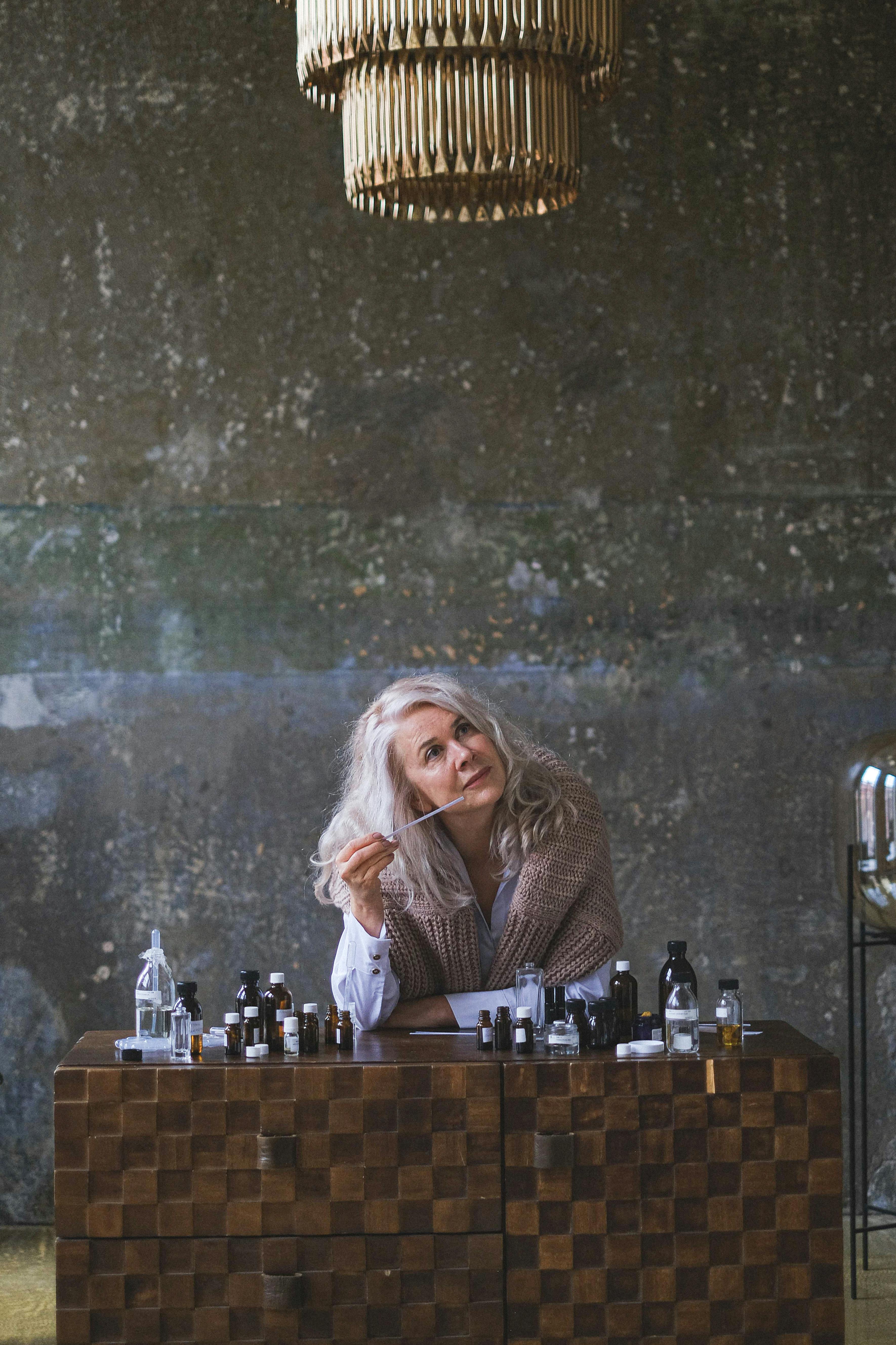 A Woman Standing at the Table · Free Stock Photo