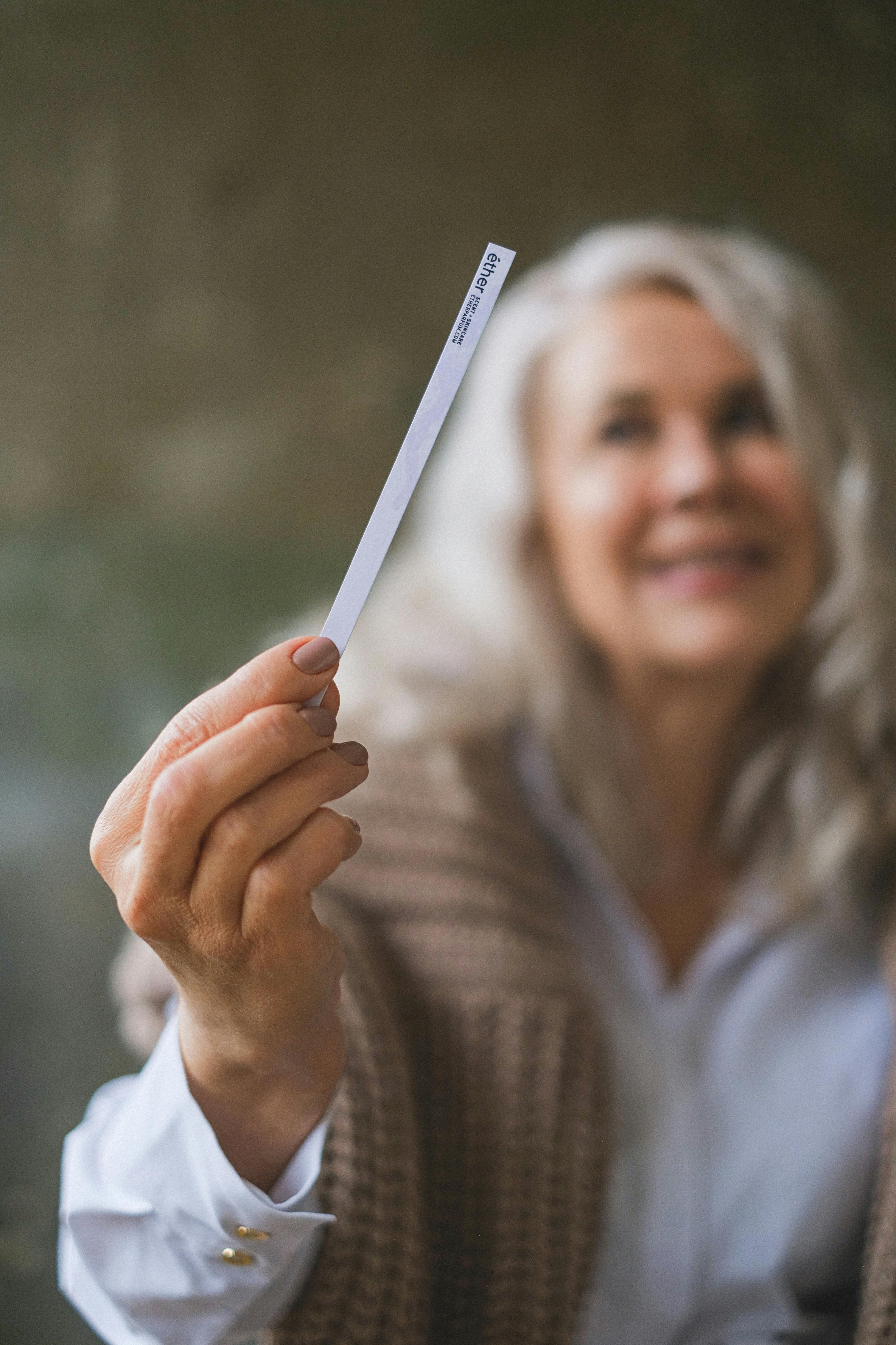 A Woman Holding White Paper · Free Stock Photo