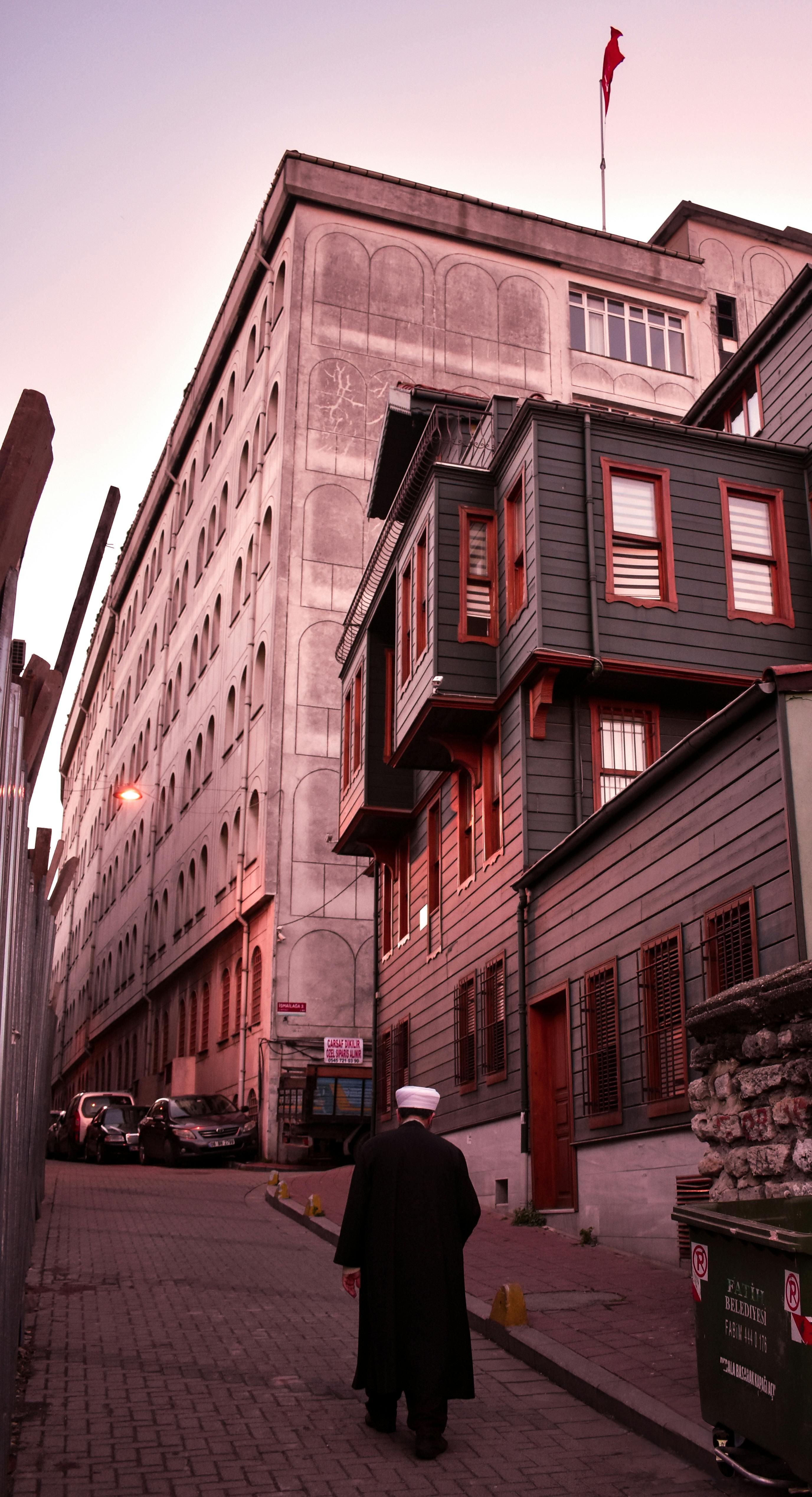 Man in Traditional Clothes Walking City Street · Free Stock Photo