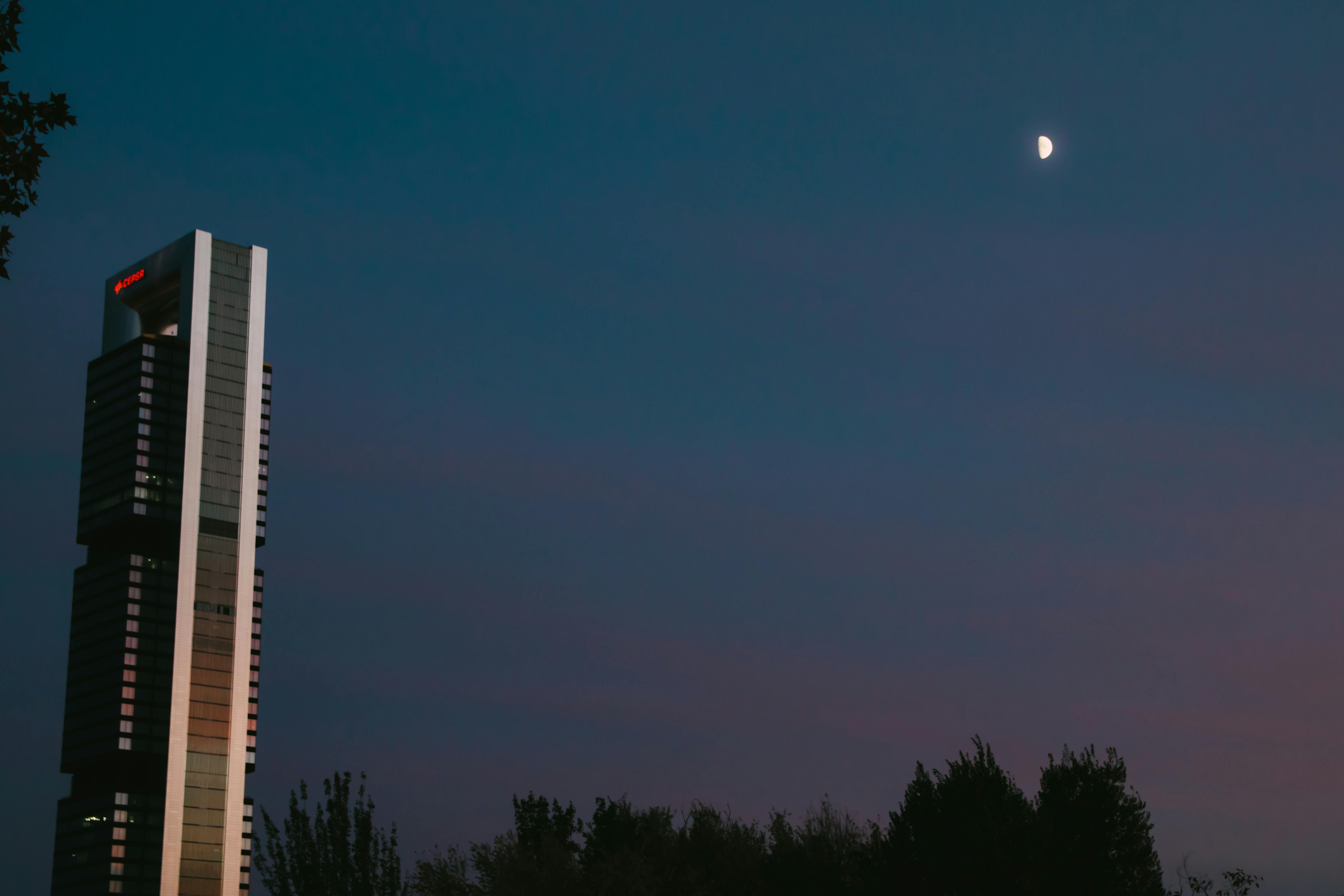 Building Under Blue Sky with Half Moon · Free Stock Photo