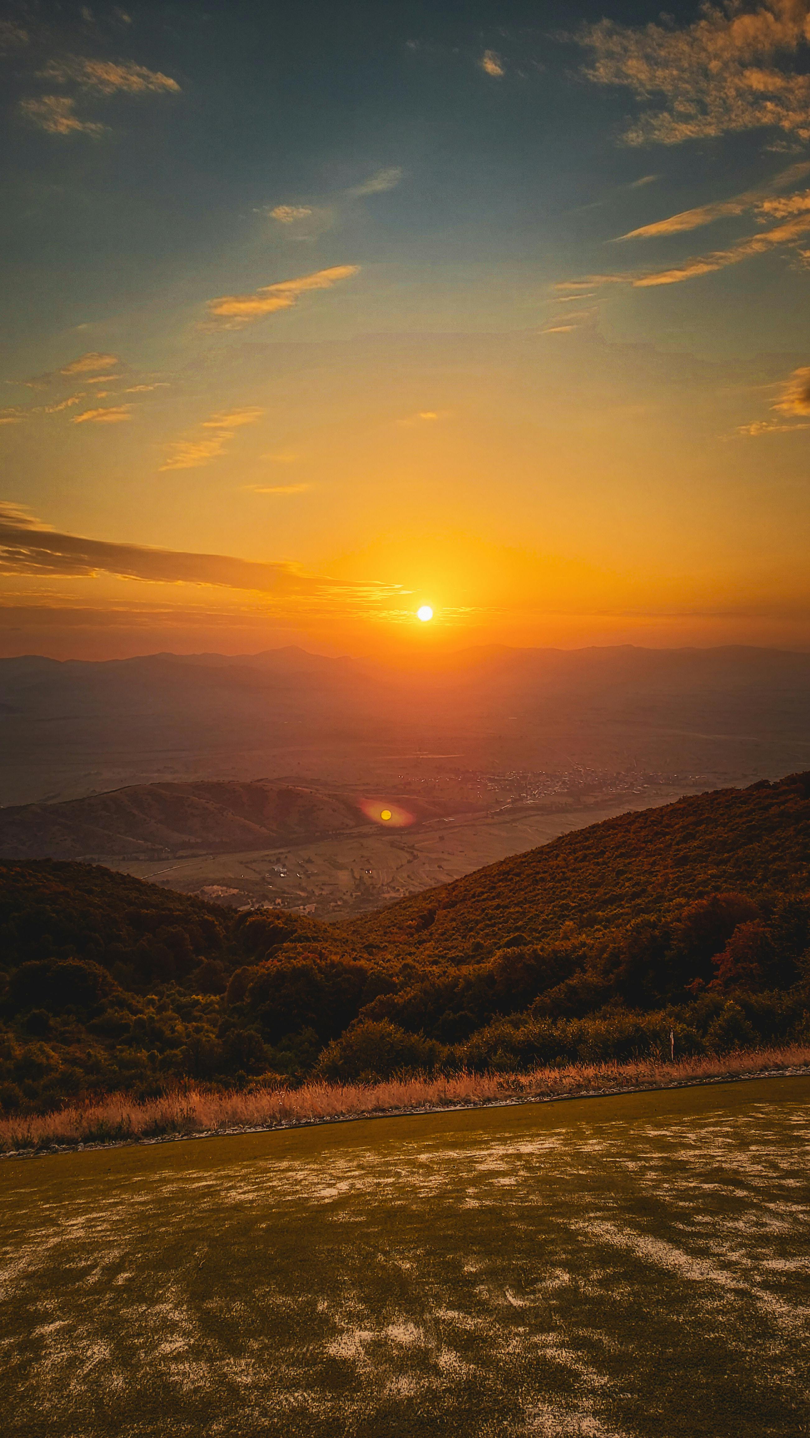 Amazing sunset over hills and rural meadow · Free Stock Photo