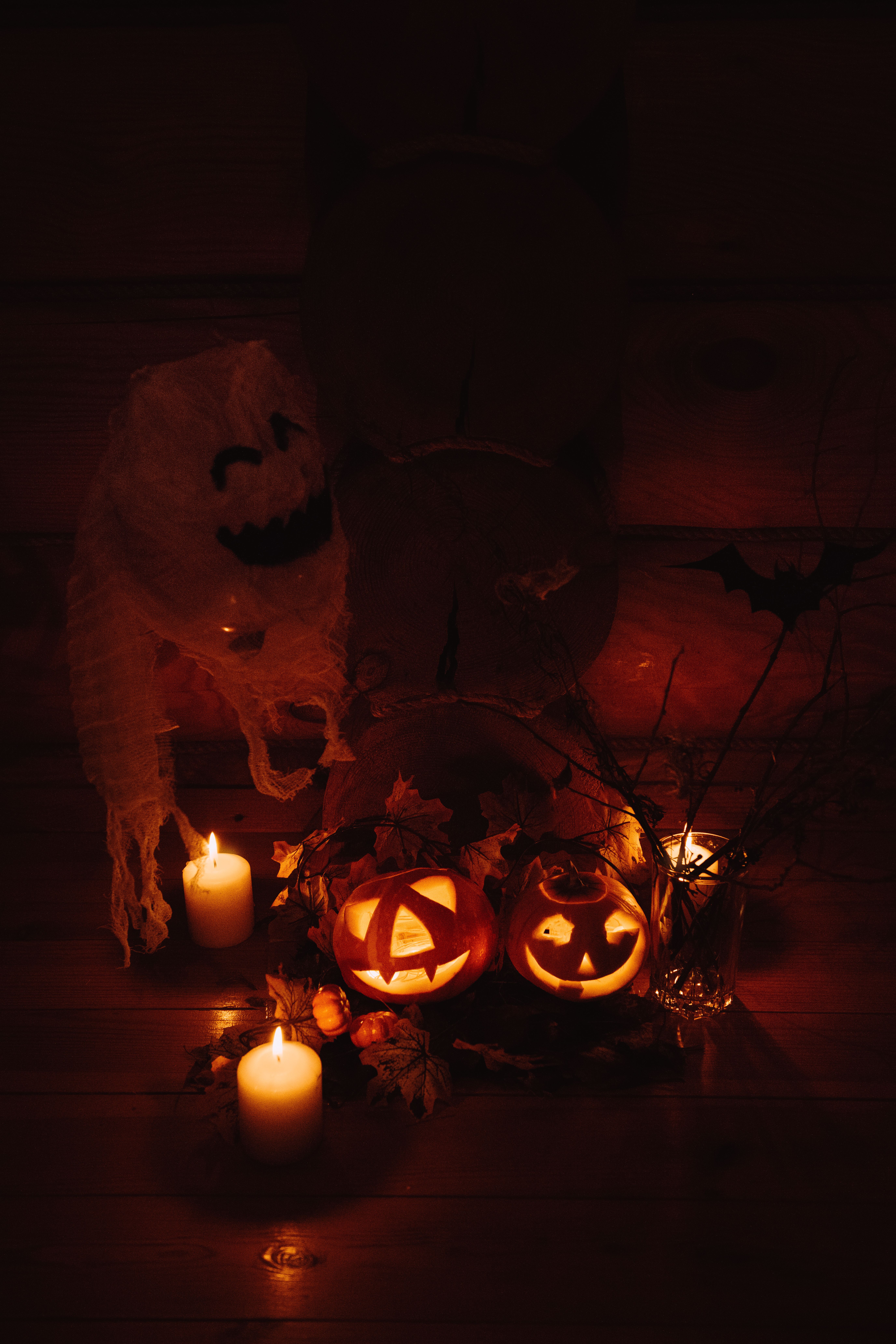 Jack O Lantern Beside Candles Halloween Decor · Free Stock Photo