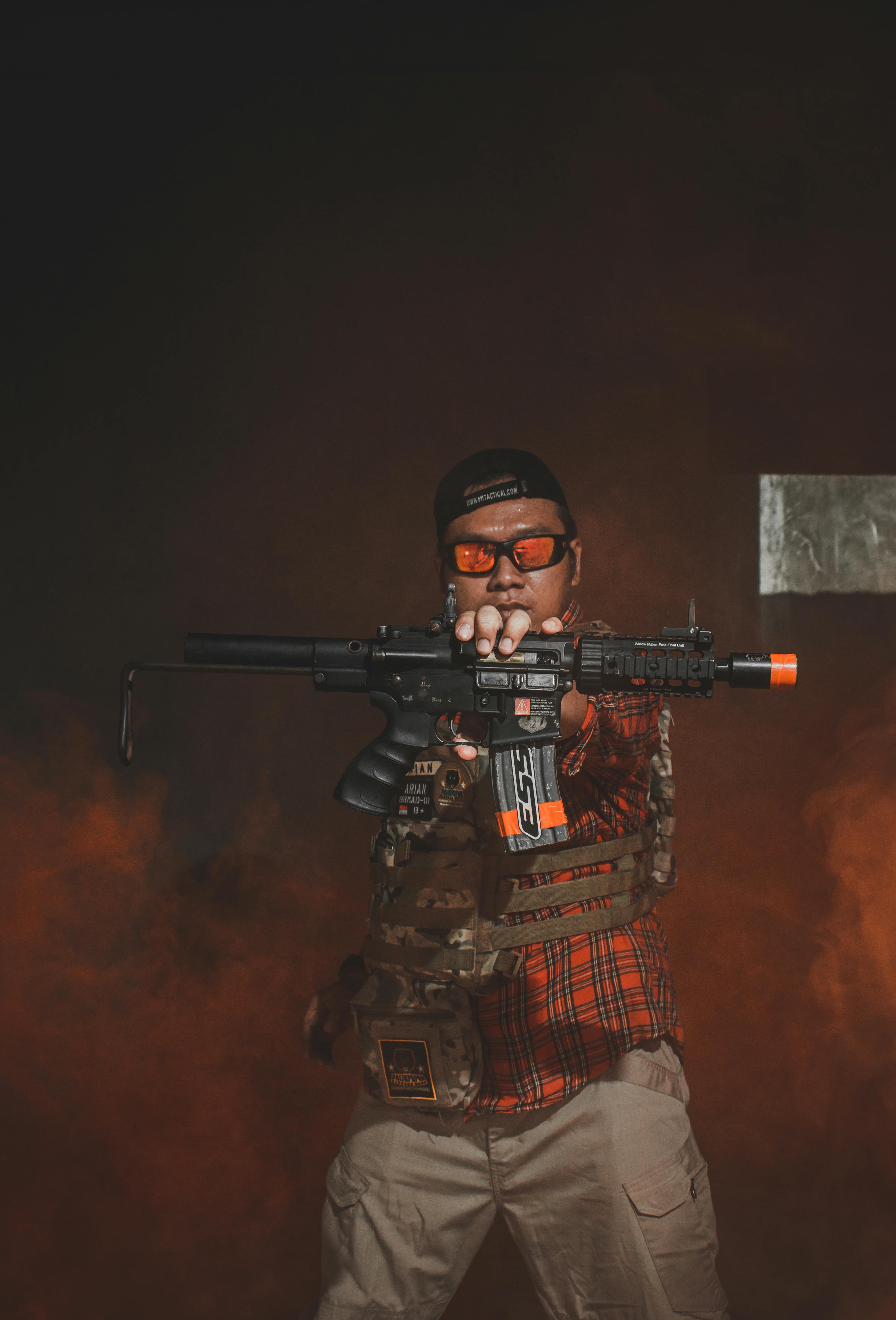 Portrait of Man Holding Gun · Free Stock Photo