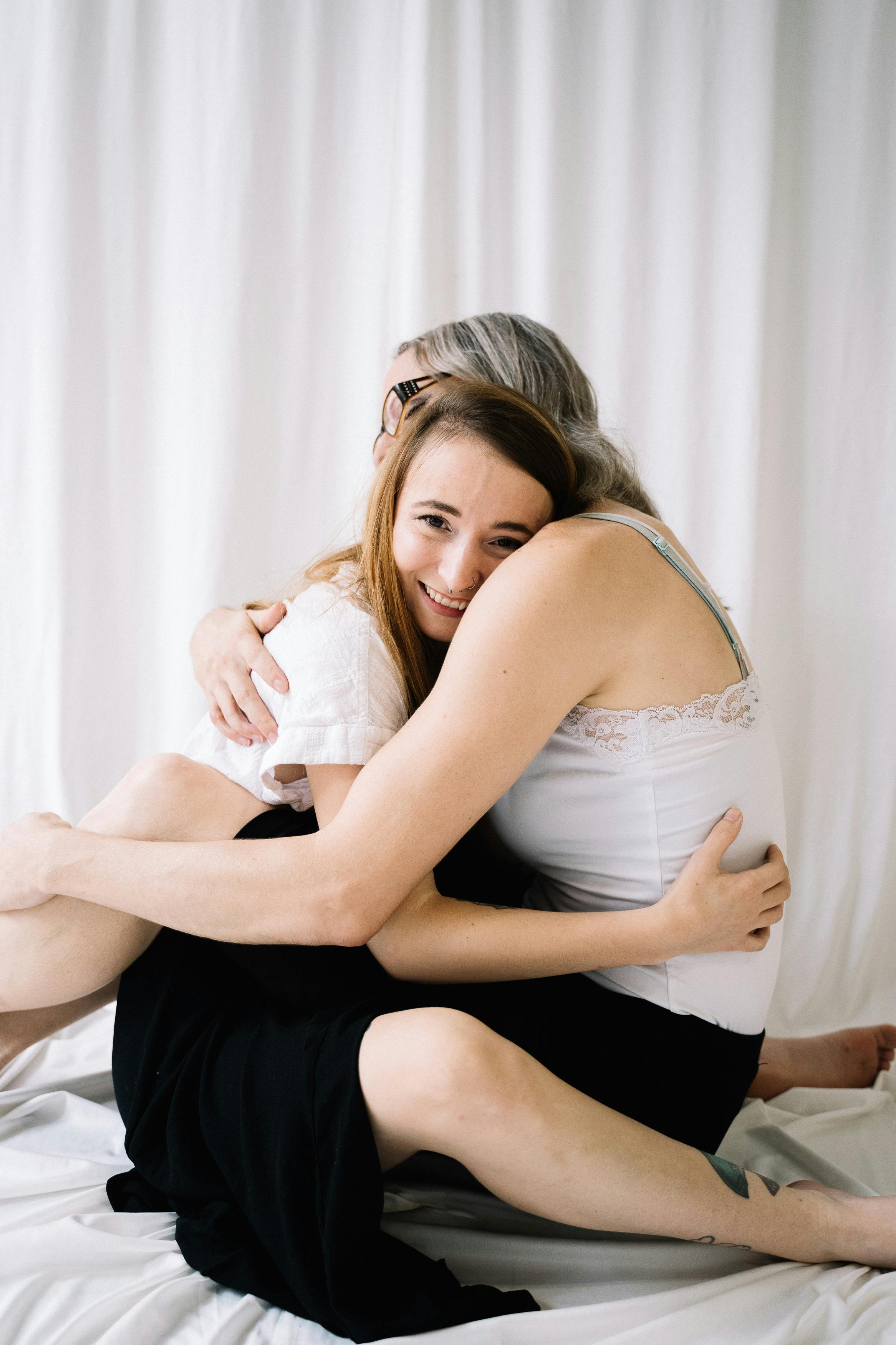 Women Hugging Each Other on Bed · Free Stock Photo