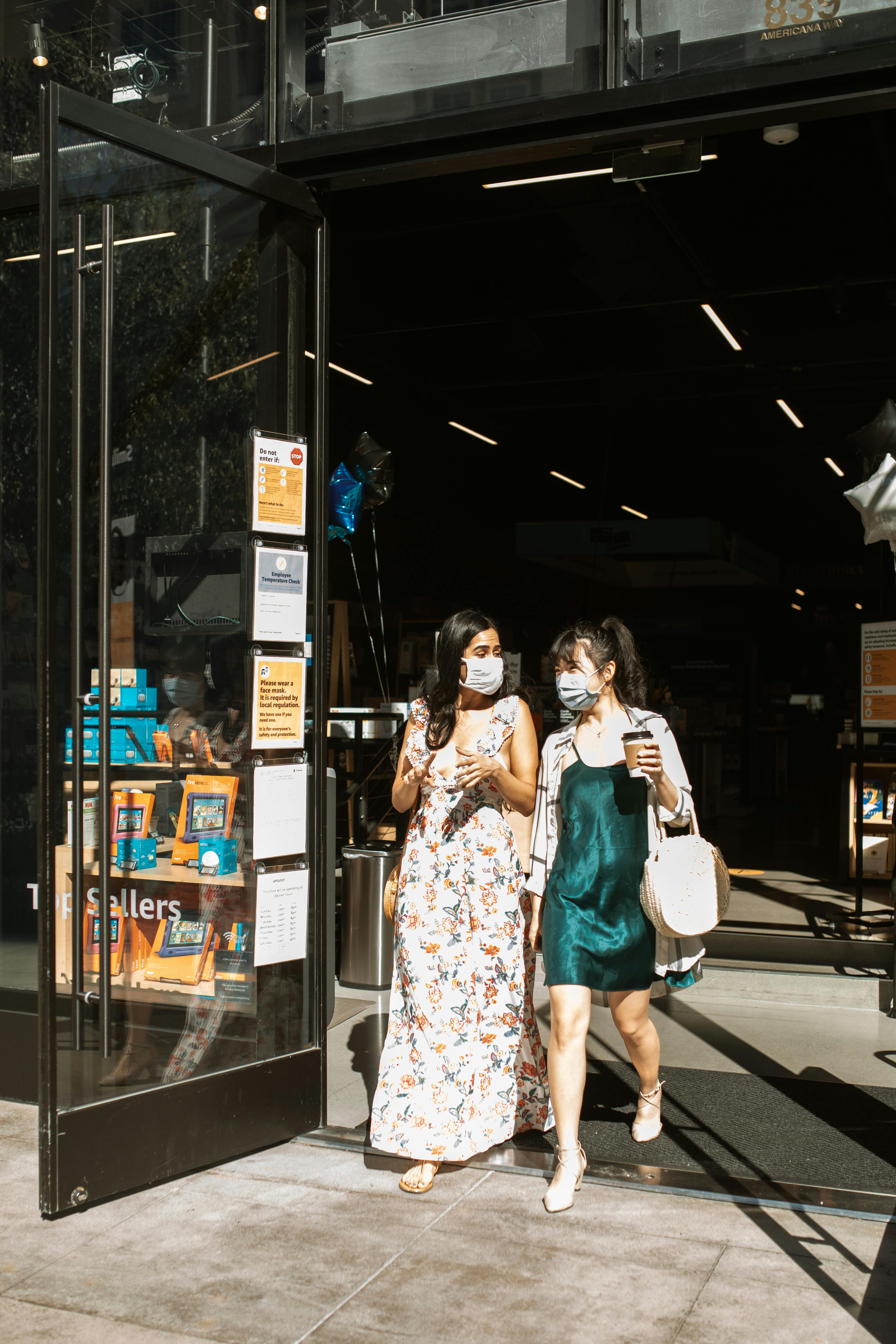 Women in Dresses and Face Masks Walking Out of Store · Free Stock Photo