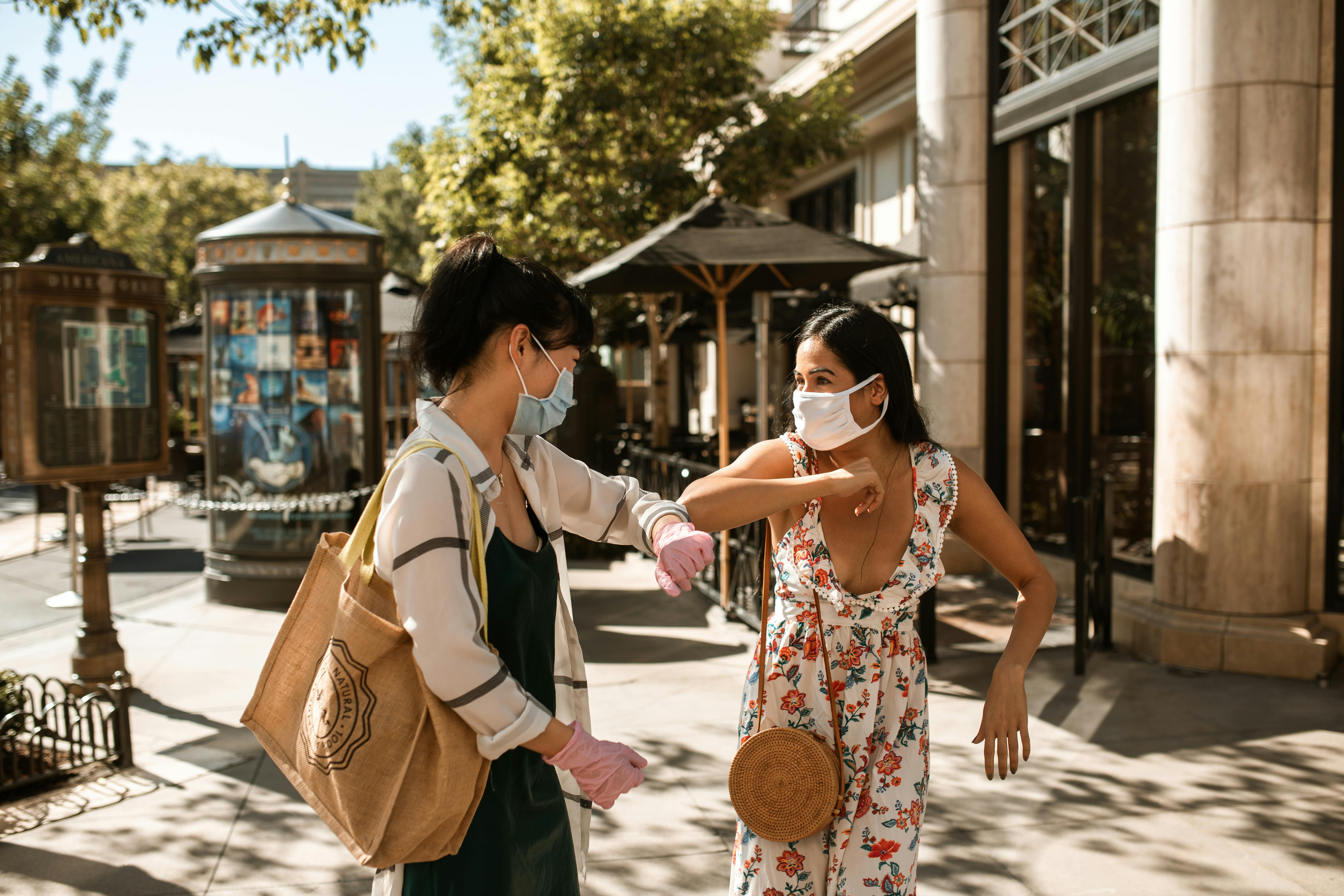 Two Women Wearing Face Masks Laughing Together · Free Stock Photo