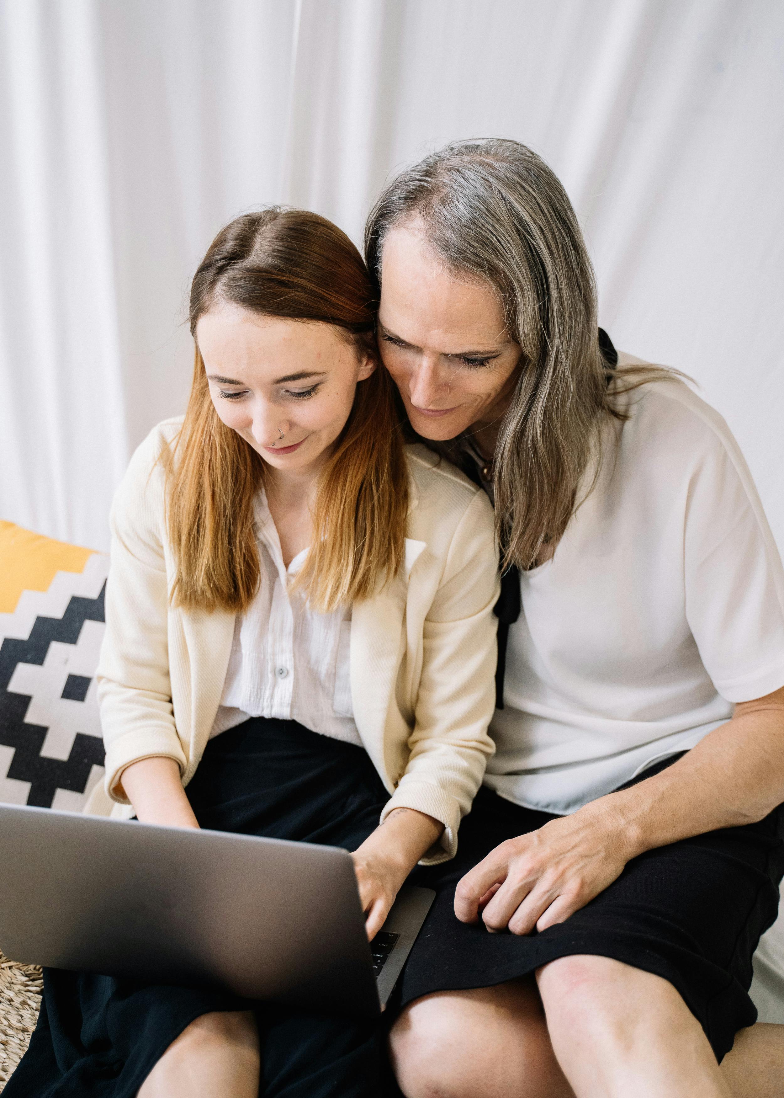 Women Sitting Down while Using Gray Laptop · Free Stock Photo
