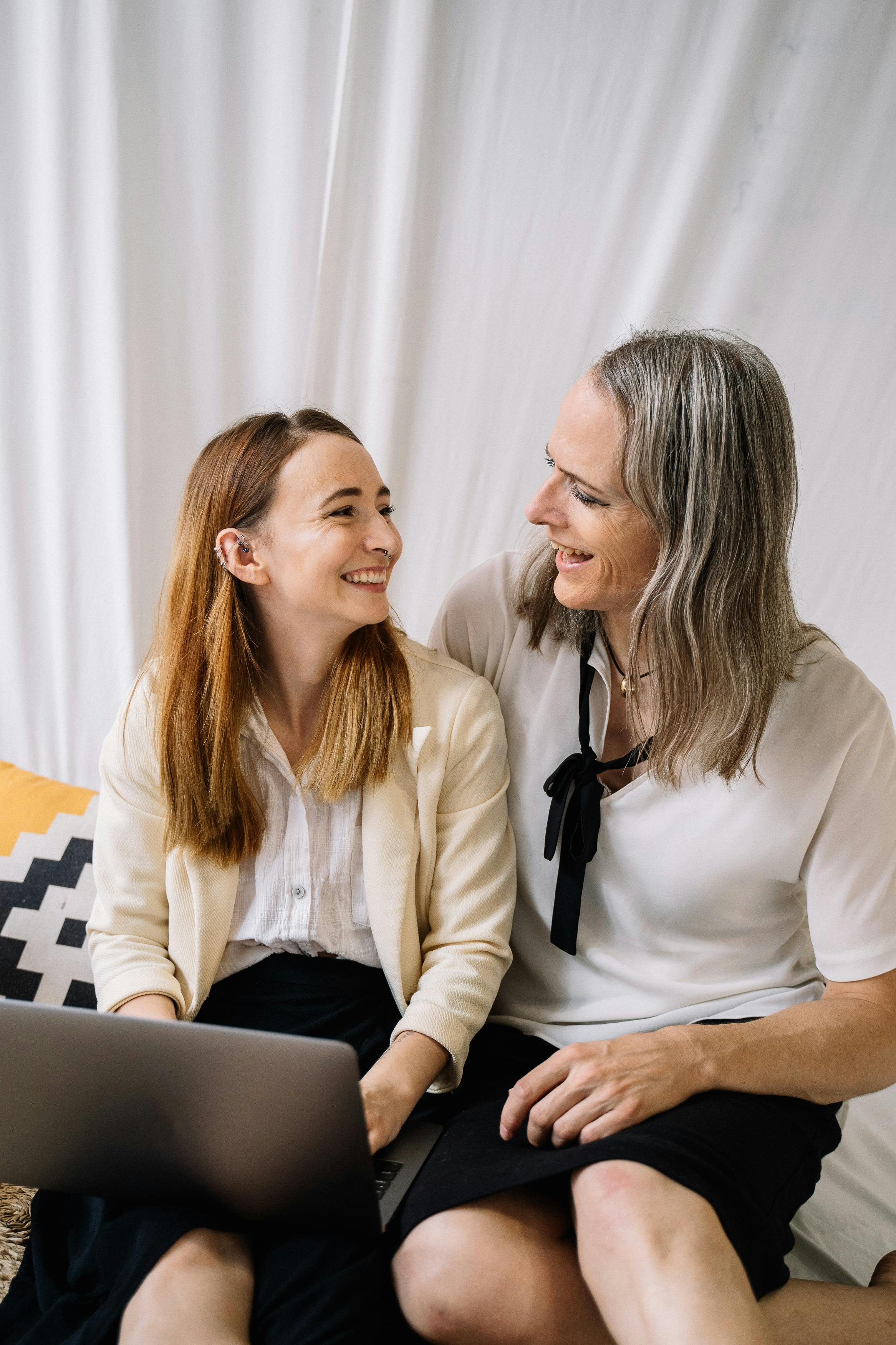 Women Sitting Down while Using Gray Laptop · Free Stock Photo