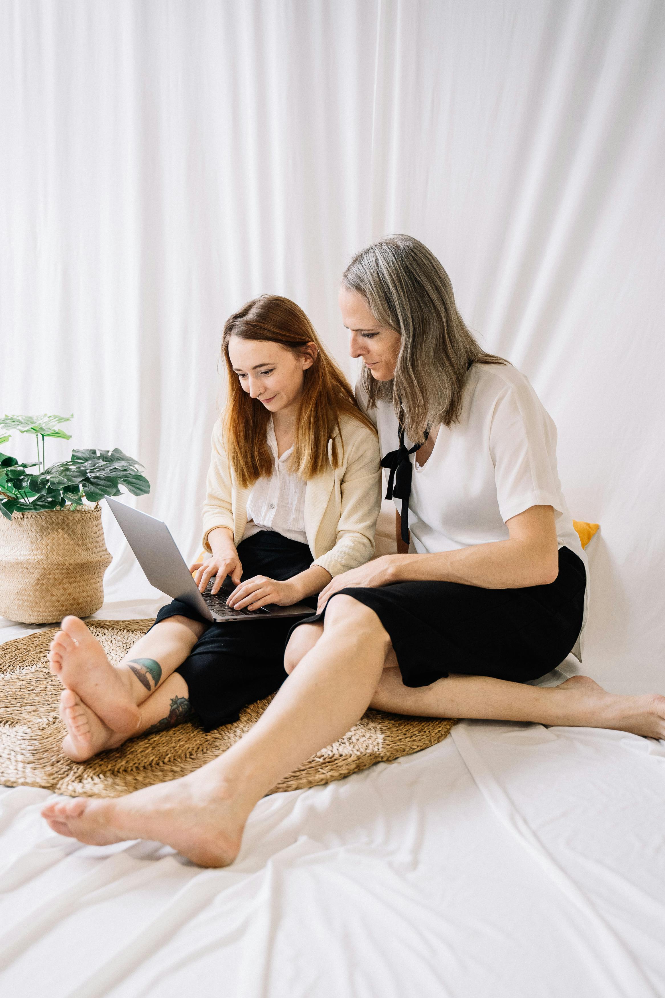 Women Sitting Down while Using Gray Laptop · Free Stock Photo