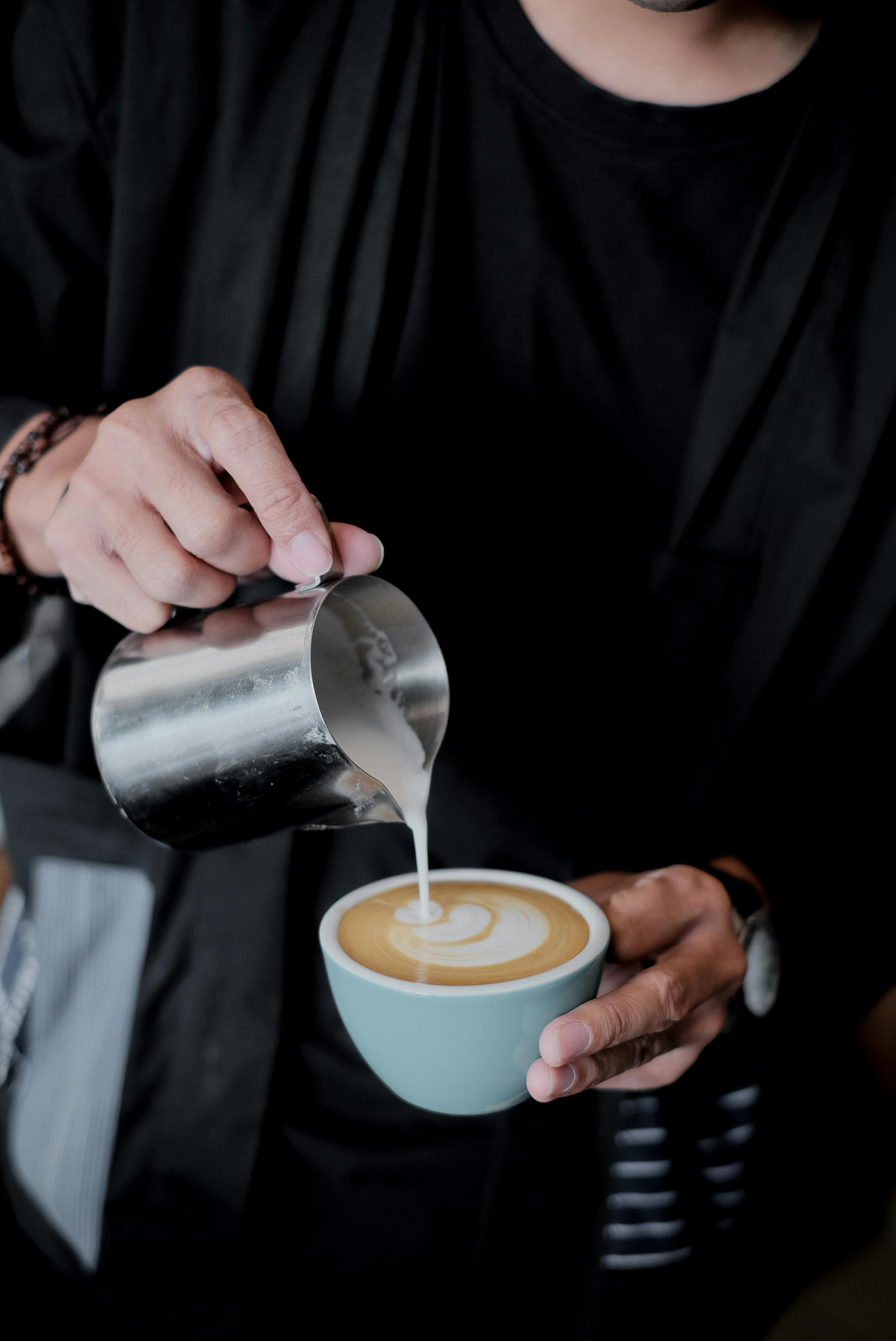 Anonymous person preparing coffee to client in cafe · Free Stock Photo