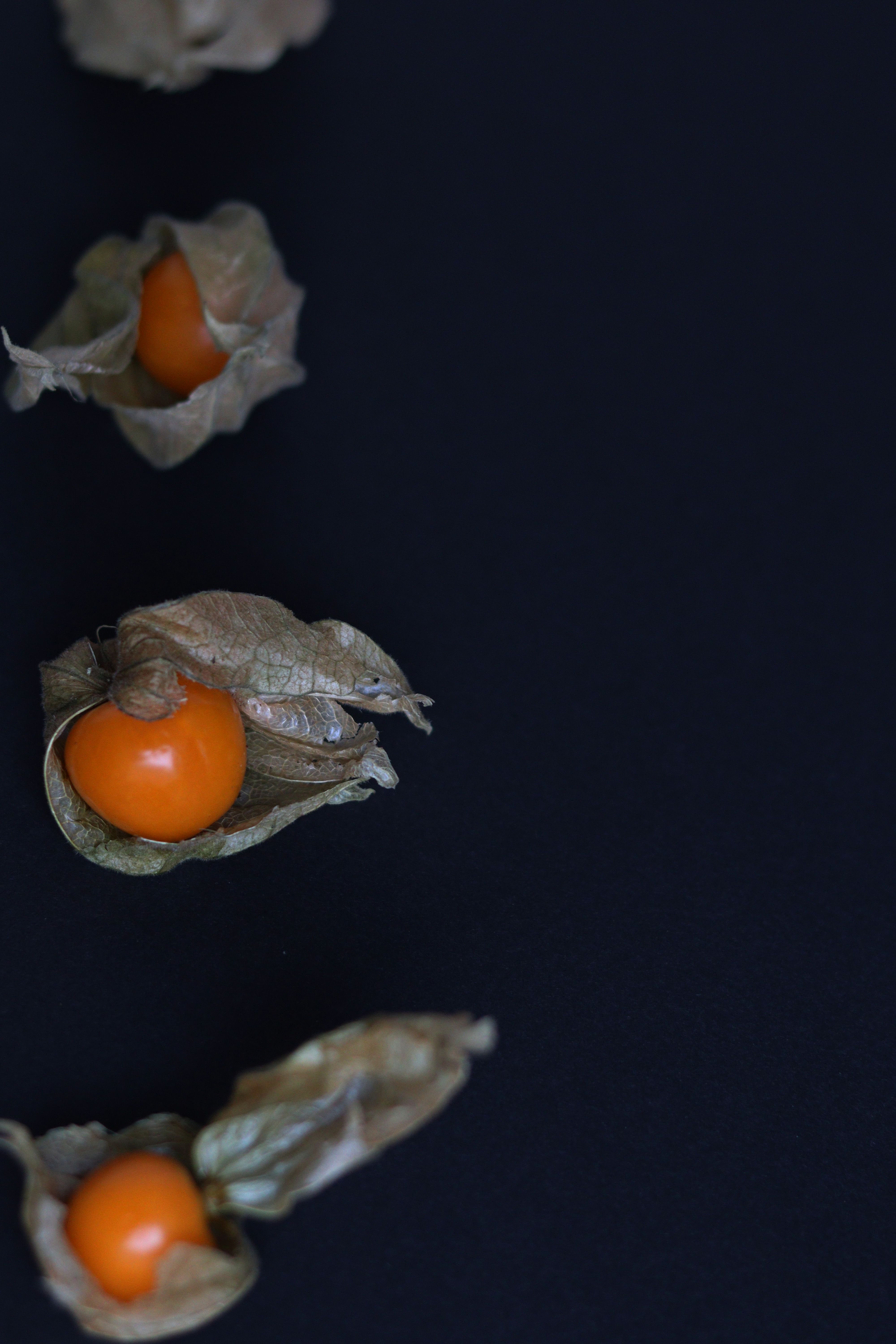 Close-up Photo of Cape Gooseberries on Red Surface · Free Stock Photo