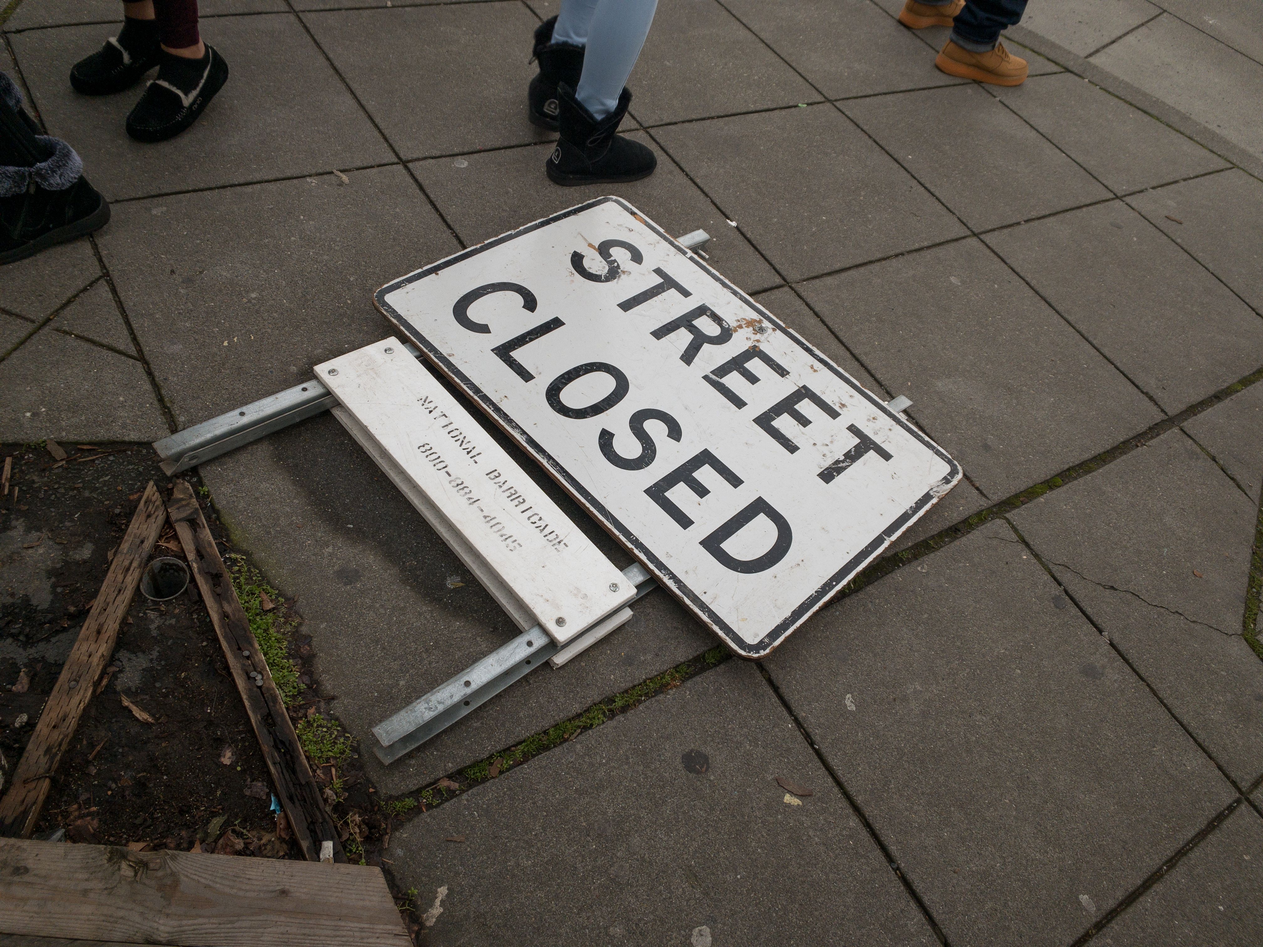 Street Signage on Concrete Sidewalk · Free Stock Photo