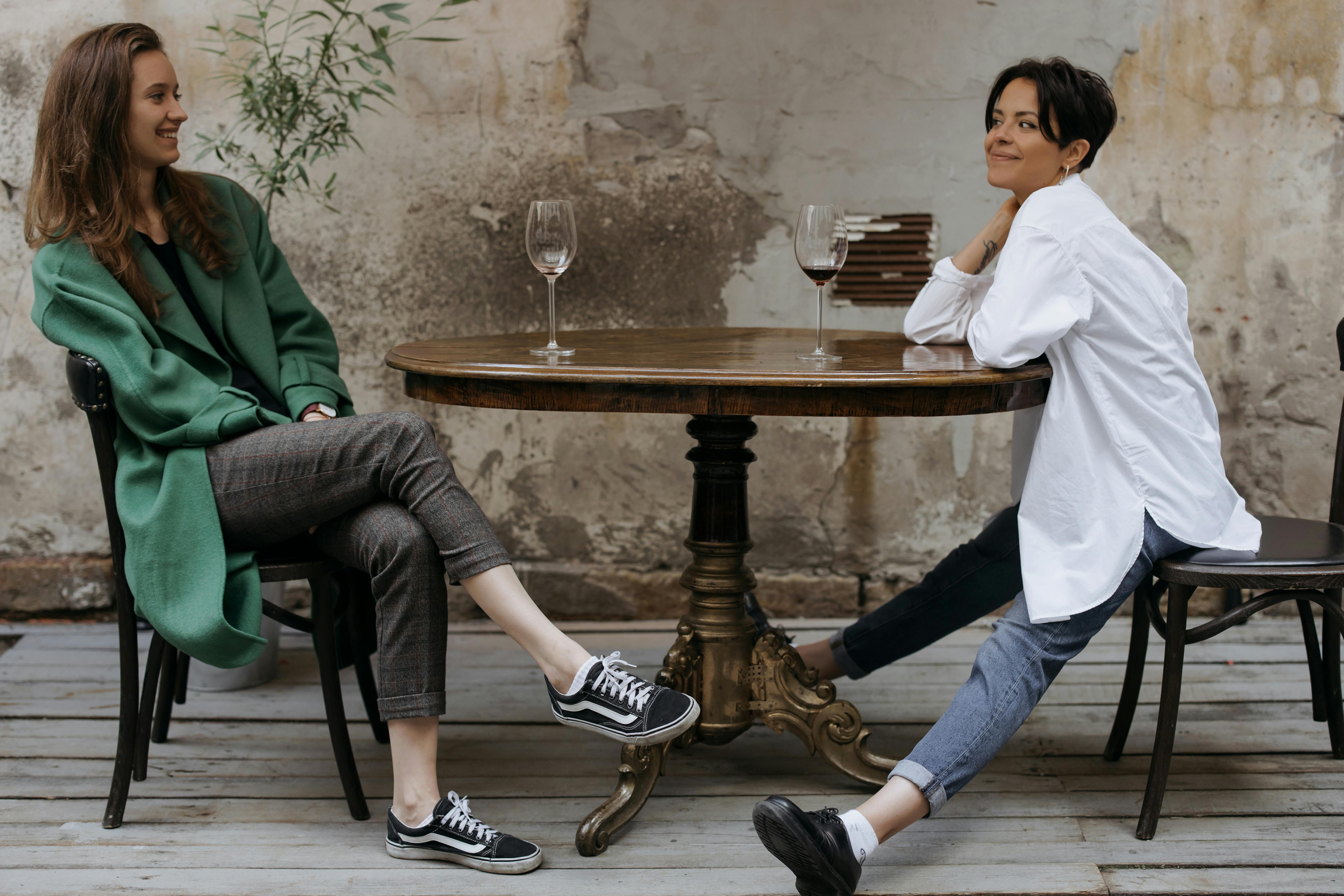 Two Women Sitting at the Table Together · Free Stock Photo