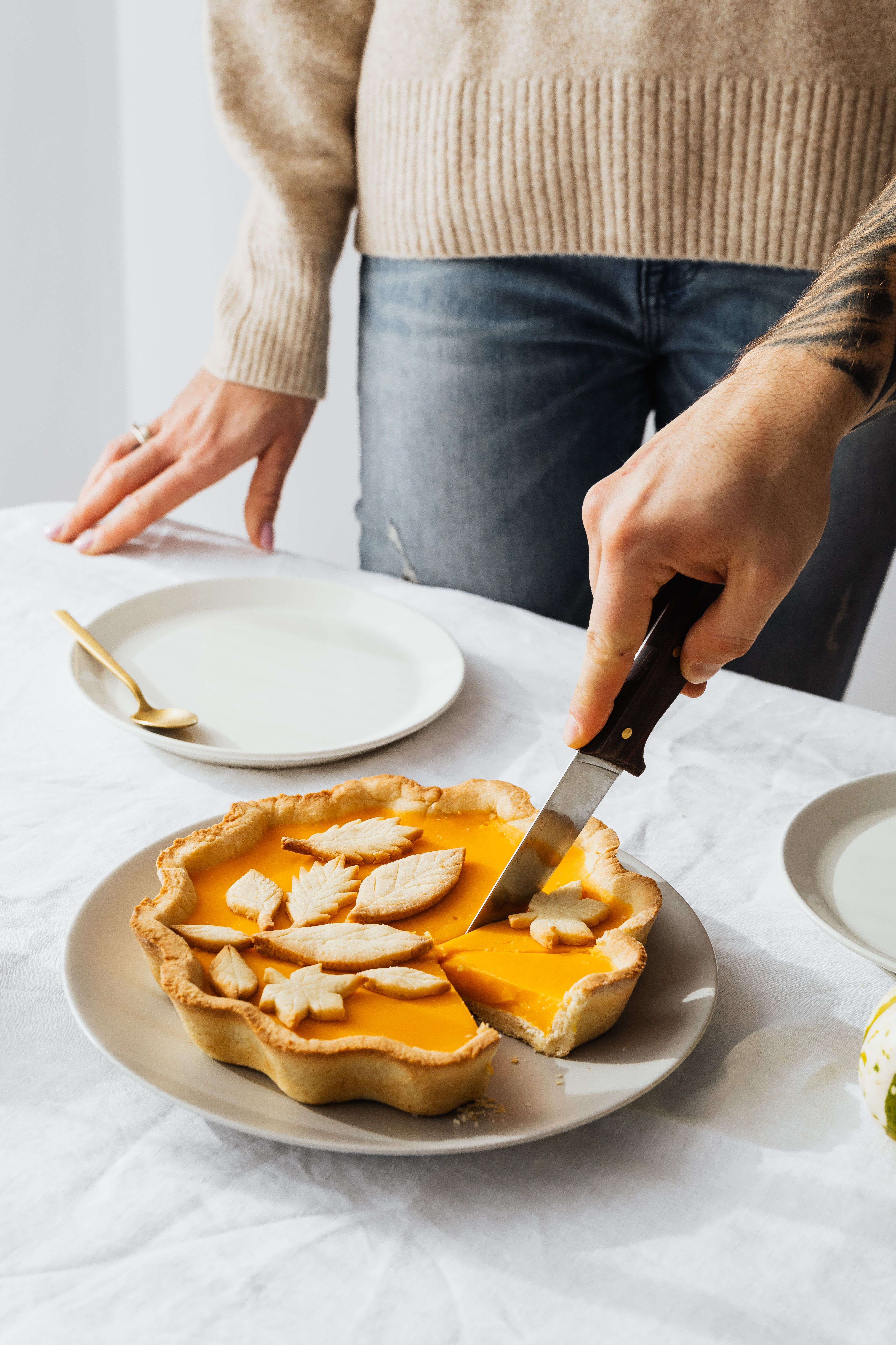Person Slicing the Pumpkin Pie Using a Knife · Free Stock Photo