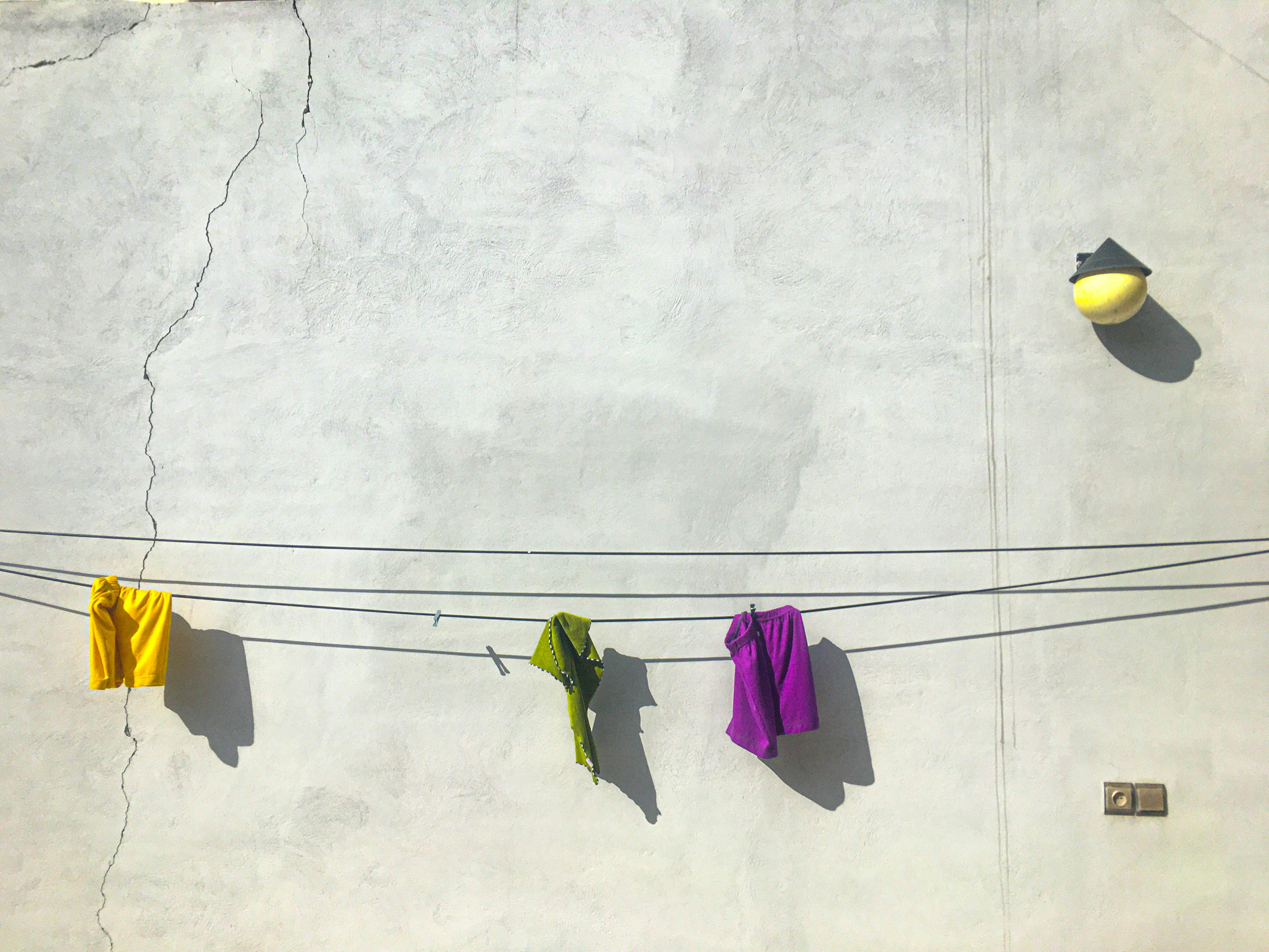 Cloths Hanging on Strings near Wall · Free Stock Photo