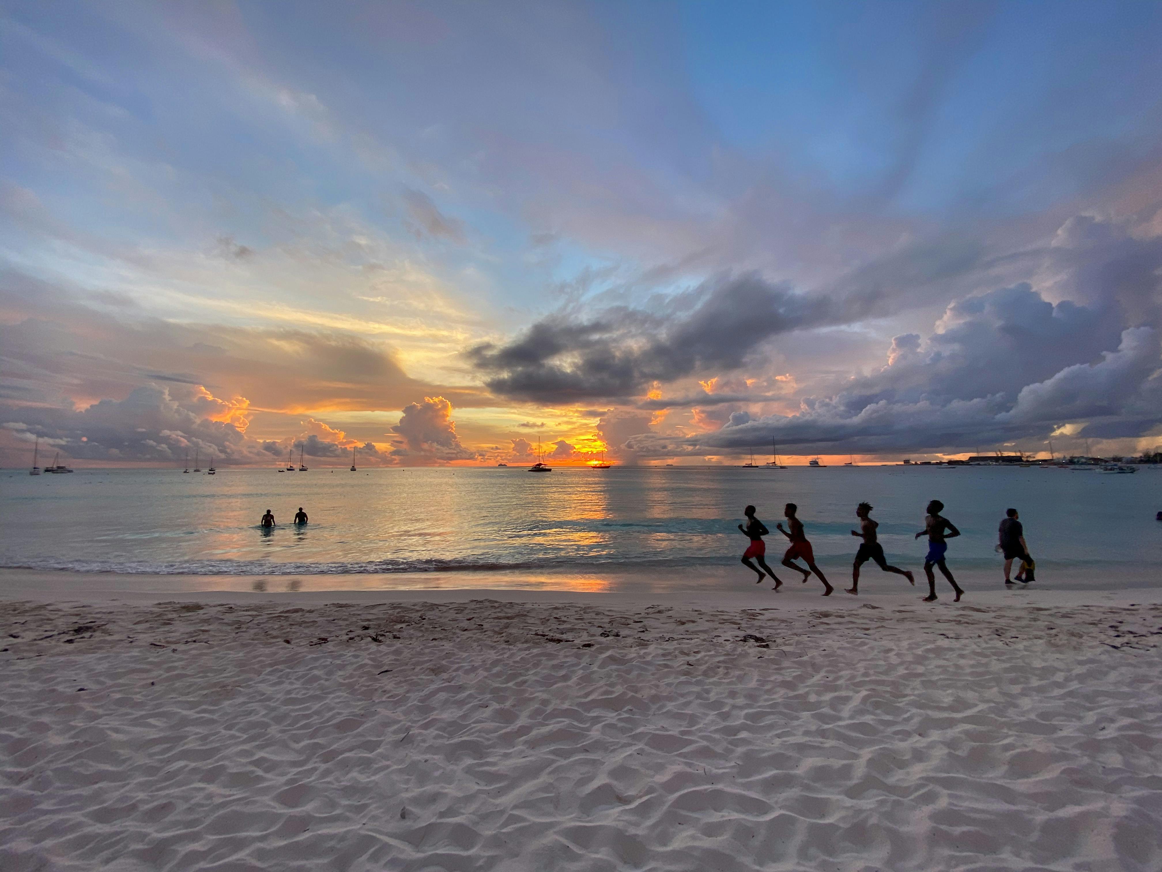 People Running on the Beach During Sunset · Free Stock Photo