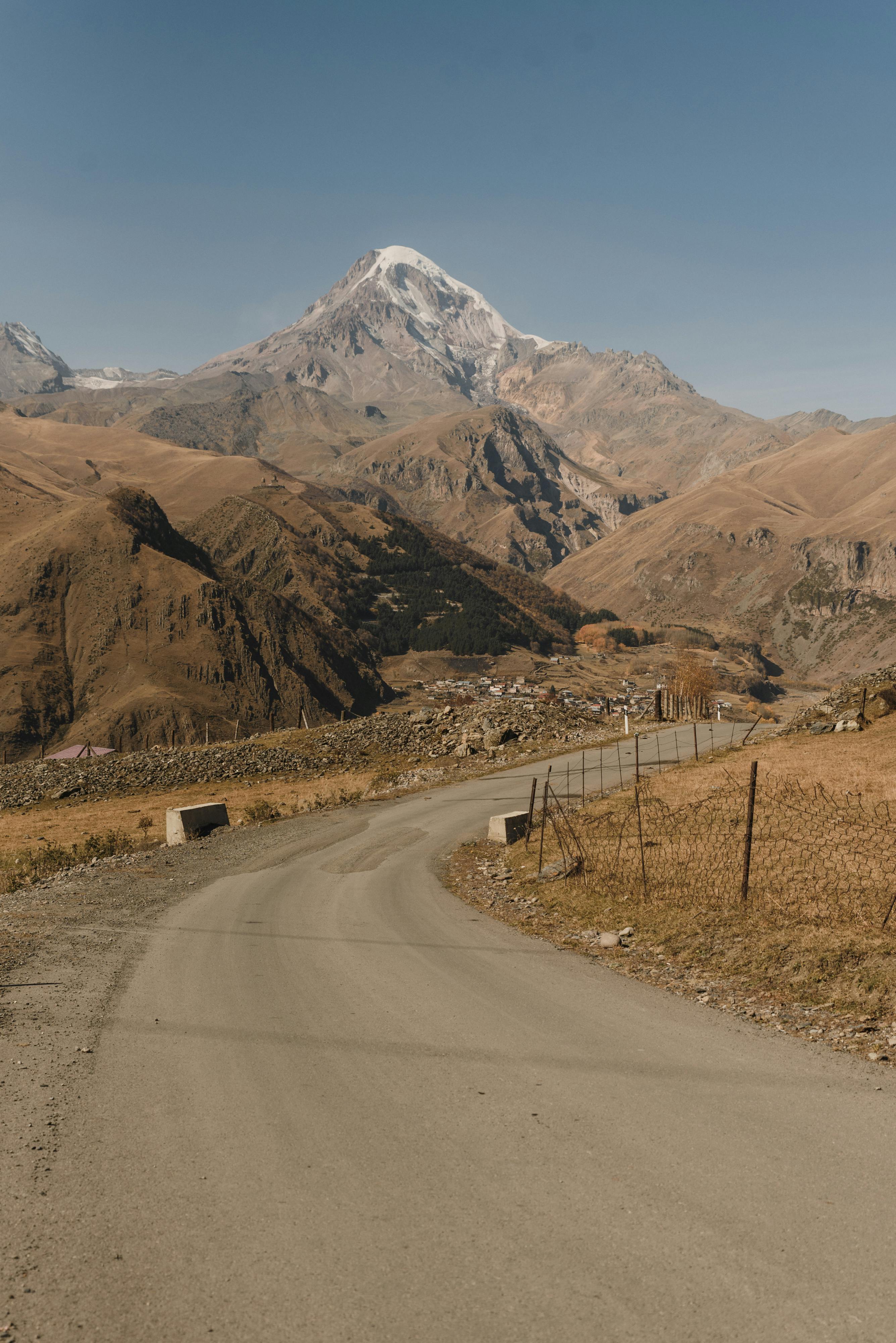 Road at the Bottom of Mountains · Free Stock Photo