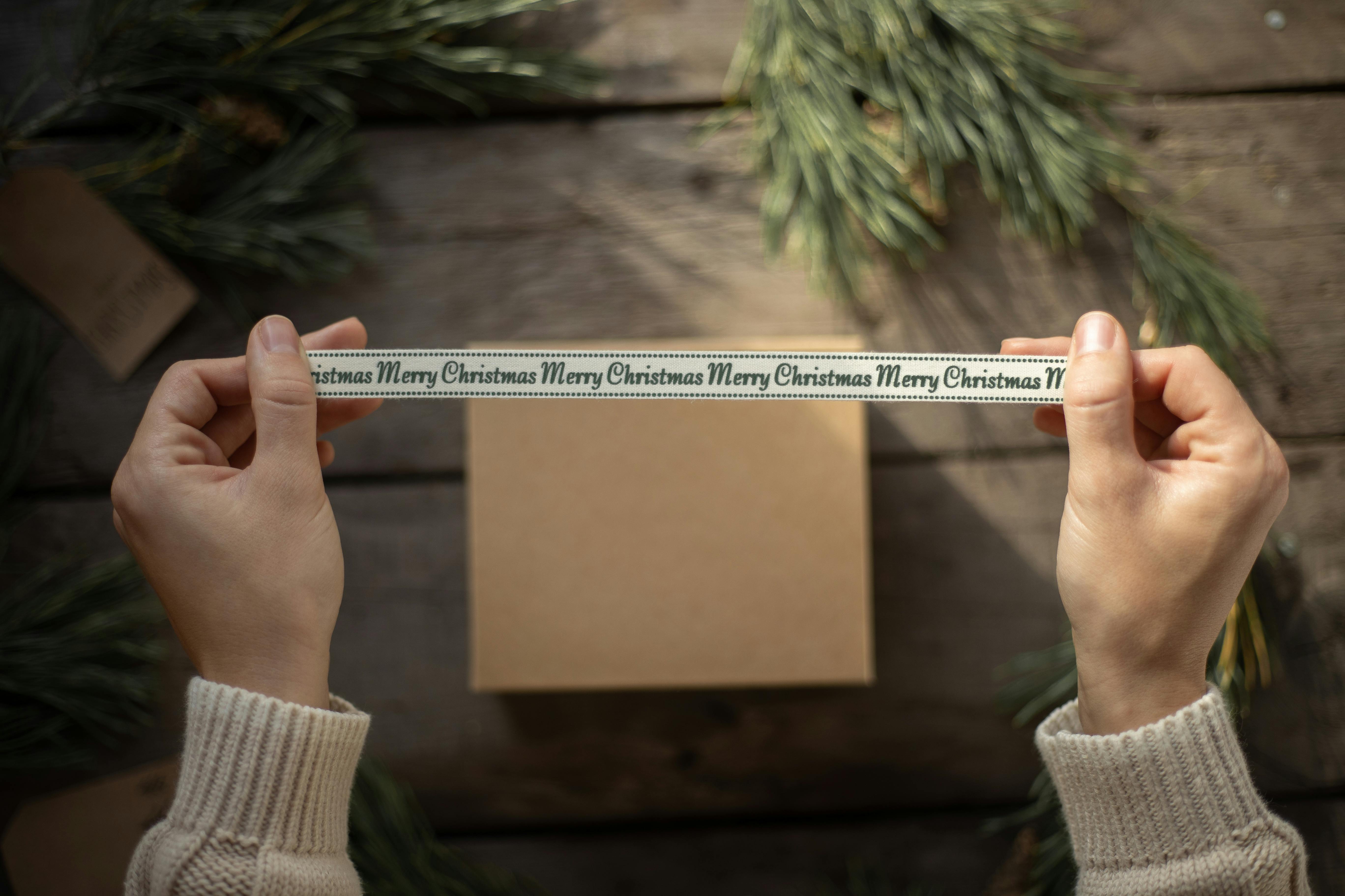 Man making Christmas arrangement with ribbon and spruce branches · Free ...